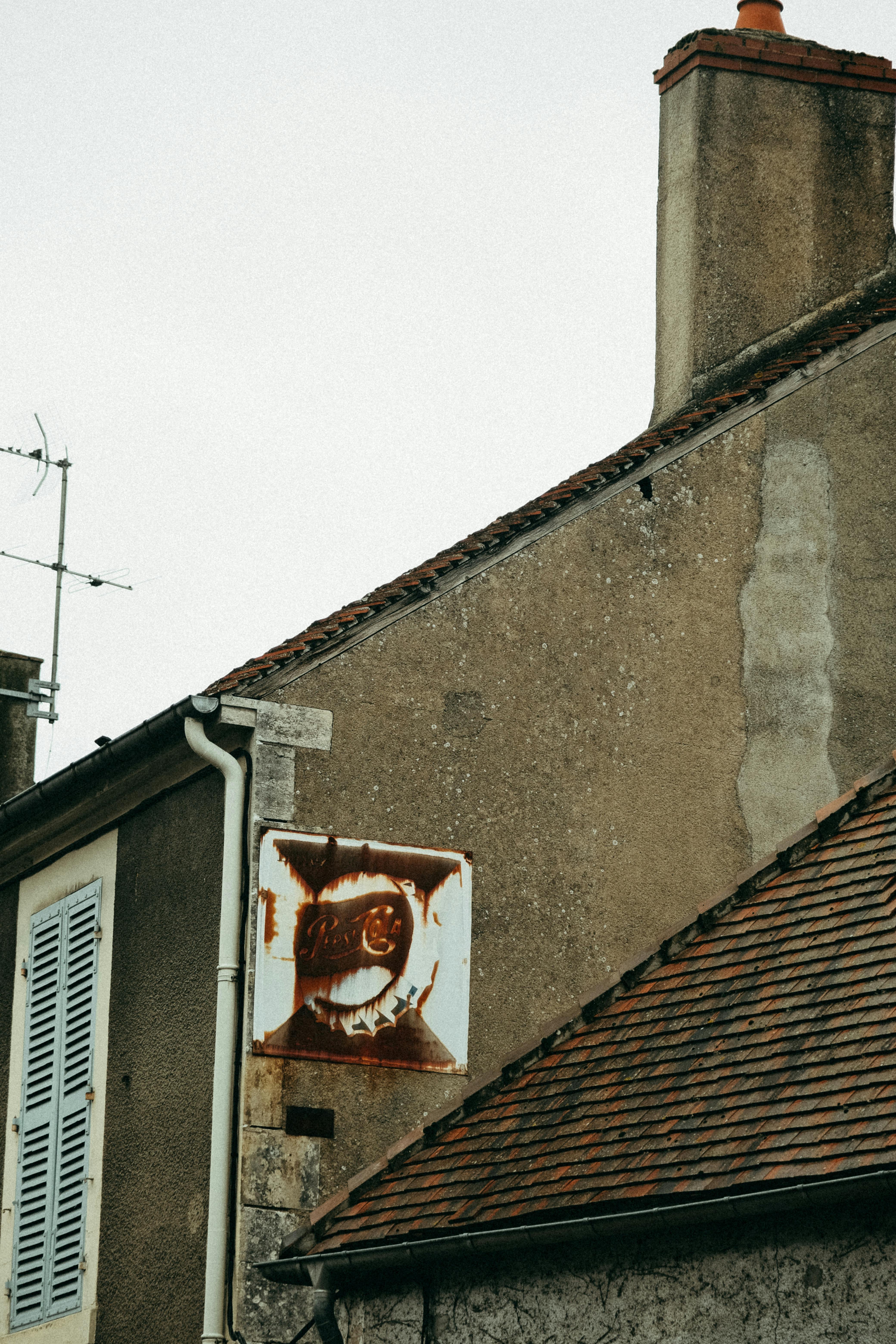 A Rusty Pepsi Cola Signboard Mounted on Wall · Free Stock Photo