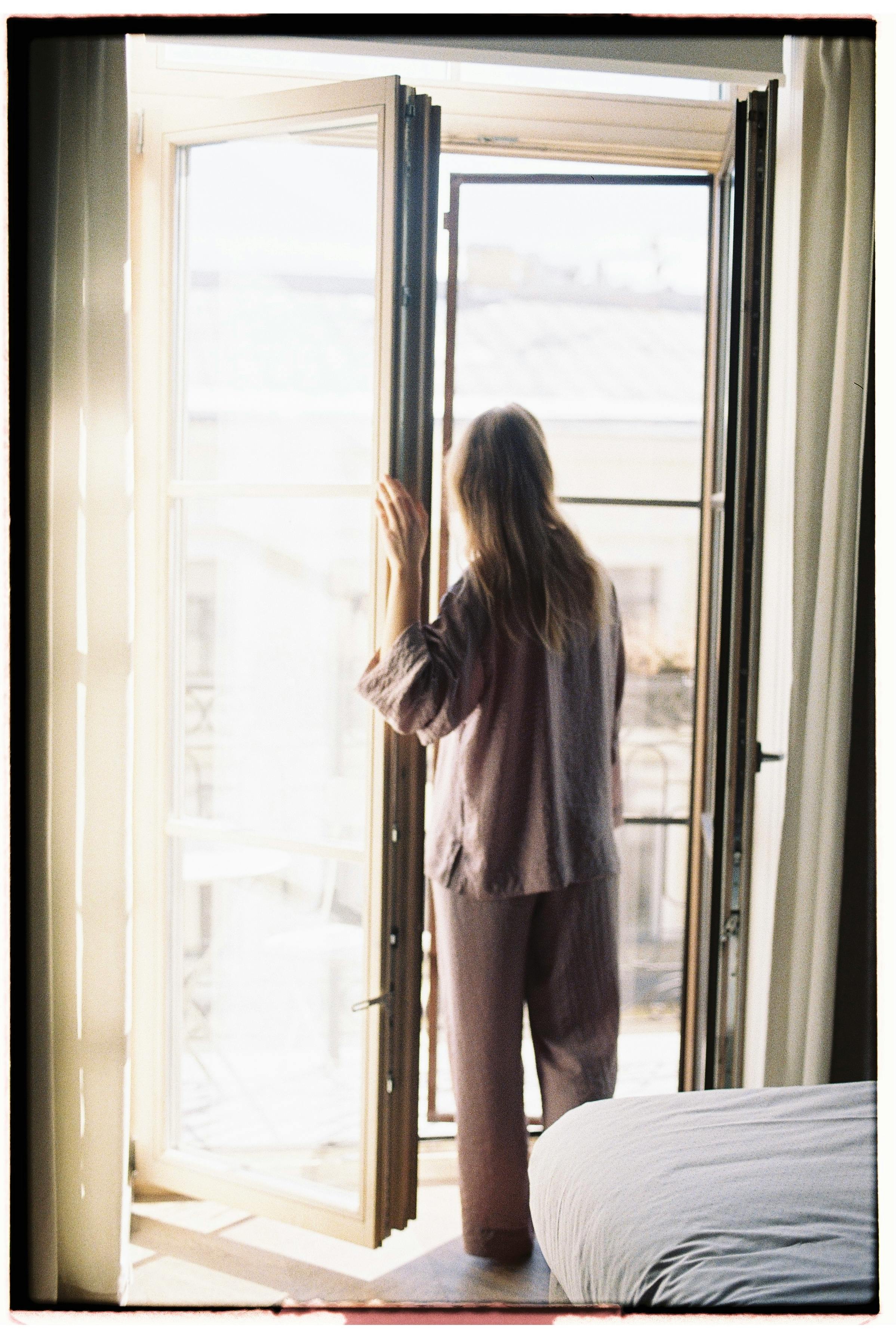 Woman Opening Balcony Door · Free Stock Photo
