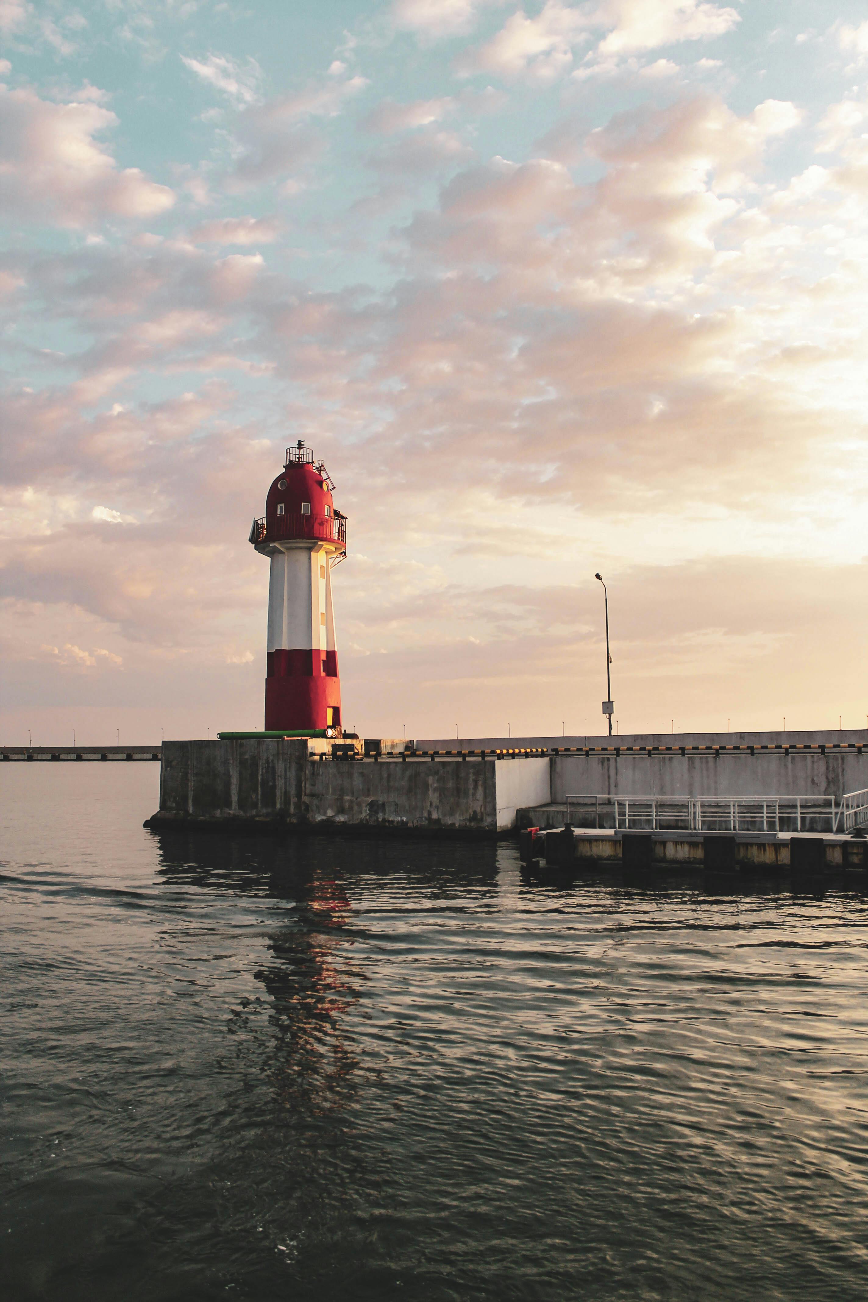 Red and White Lighthouse on Dock · Free Stock Photo