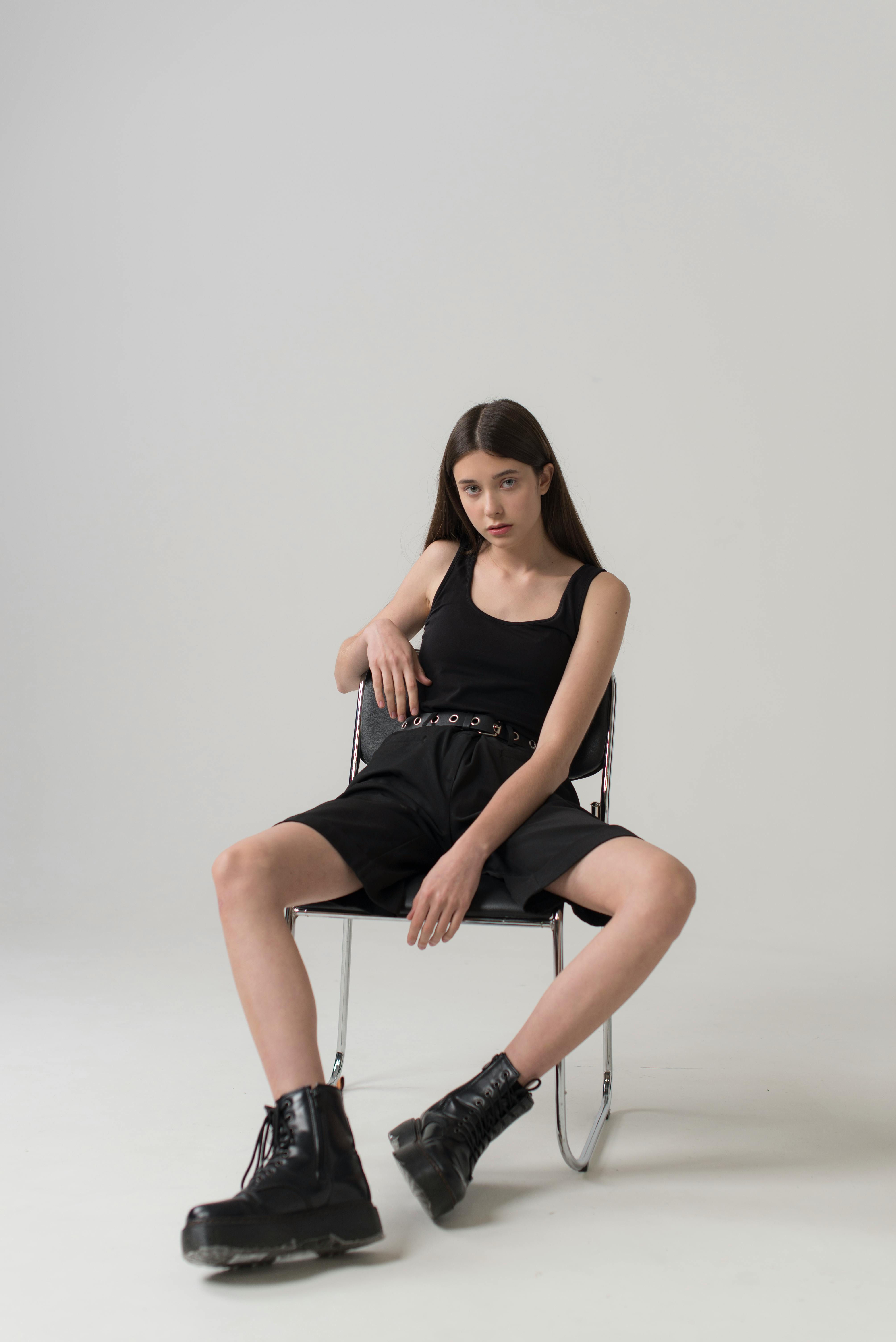 Young woman wearing eyeglasses sitting on floor · Free Stock Photo