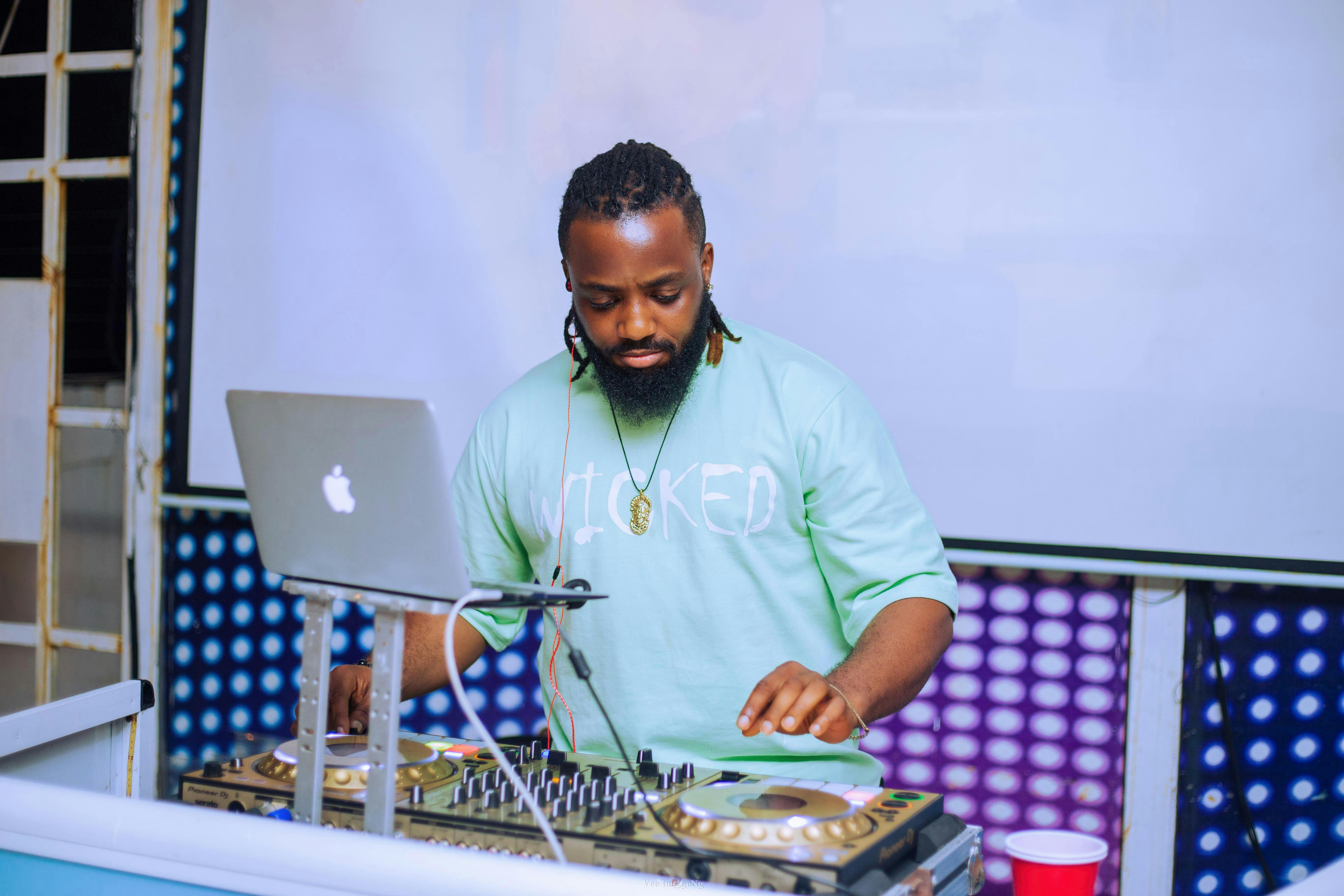 Man Operating Dj Controller · Free Stock Photo