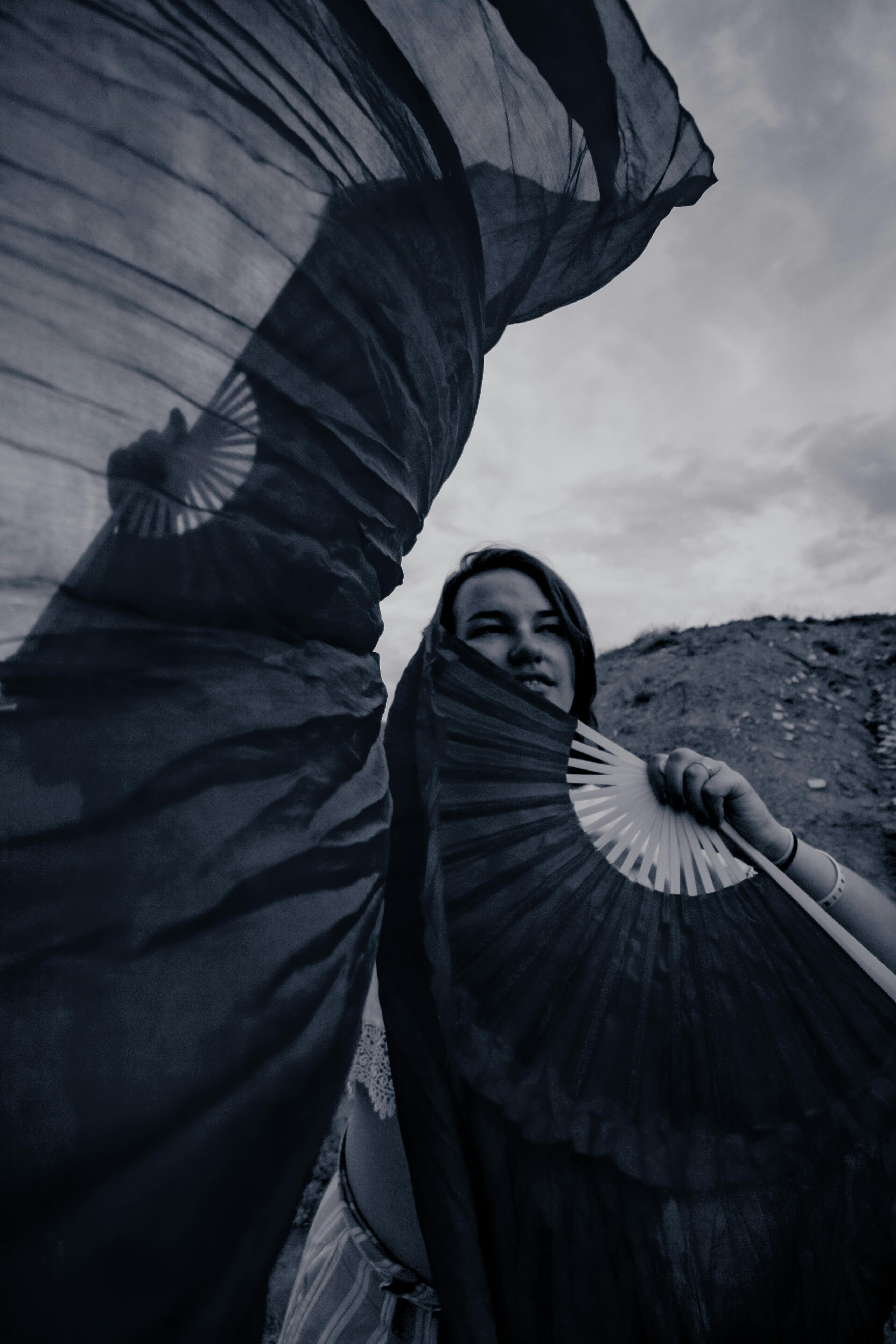 A Woman Dancing with Hand Fans · Free Stock Photo