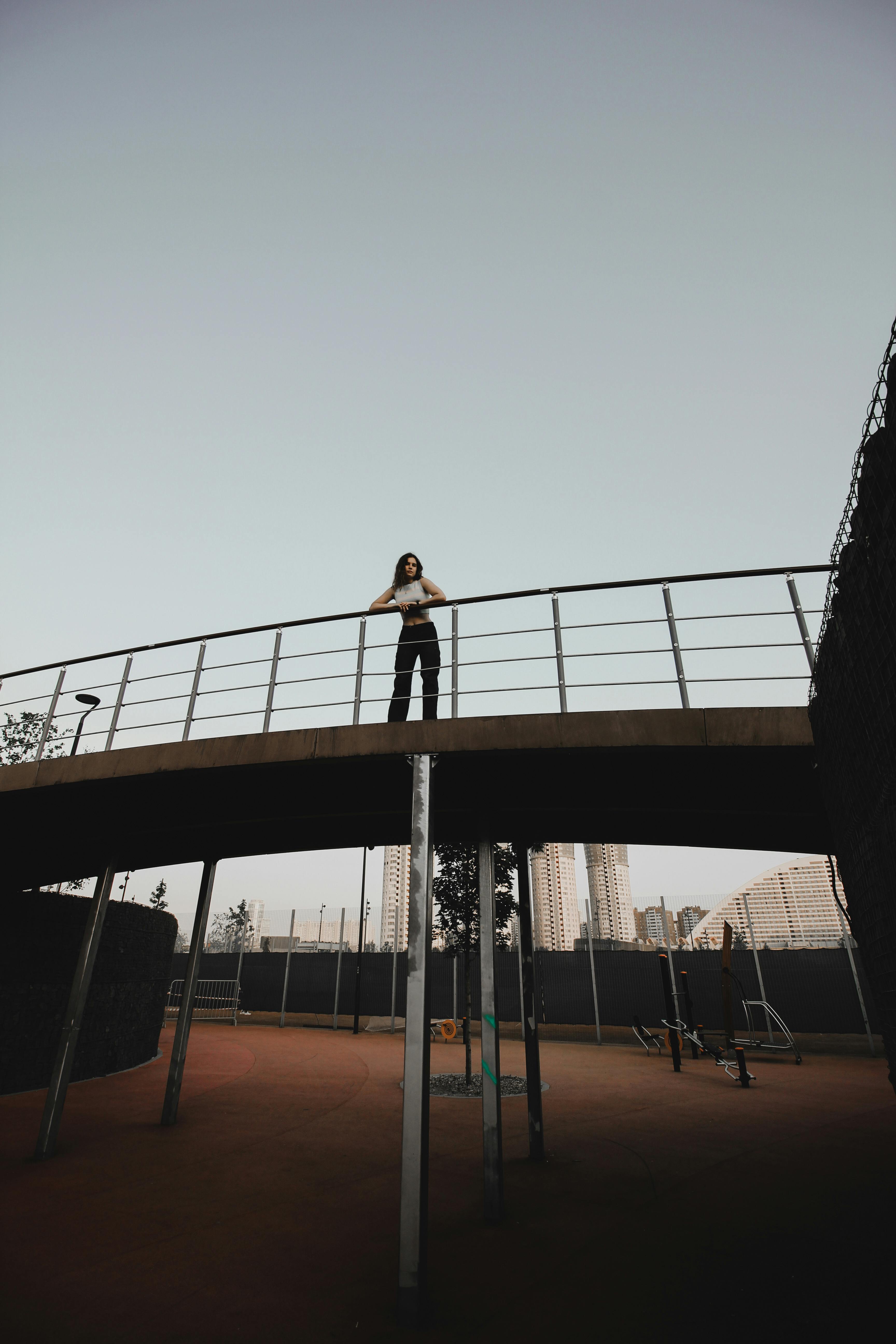 Woman on the Bridge Looking Down · Free Stock Photo