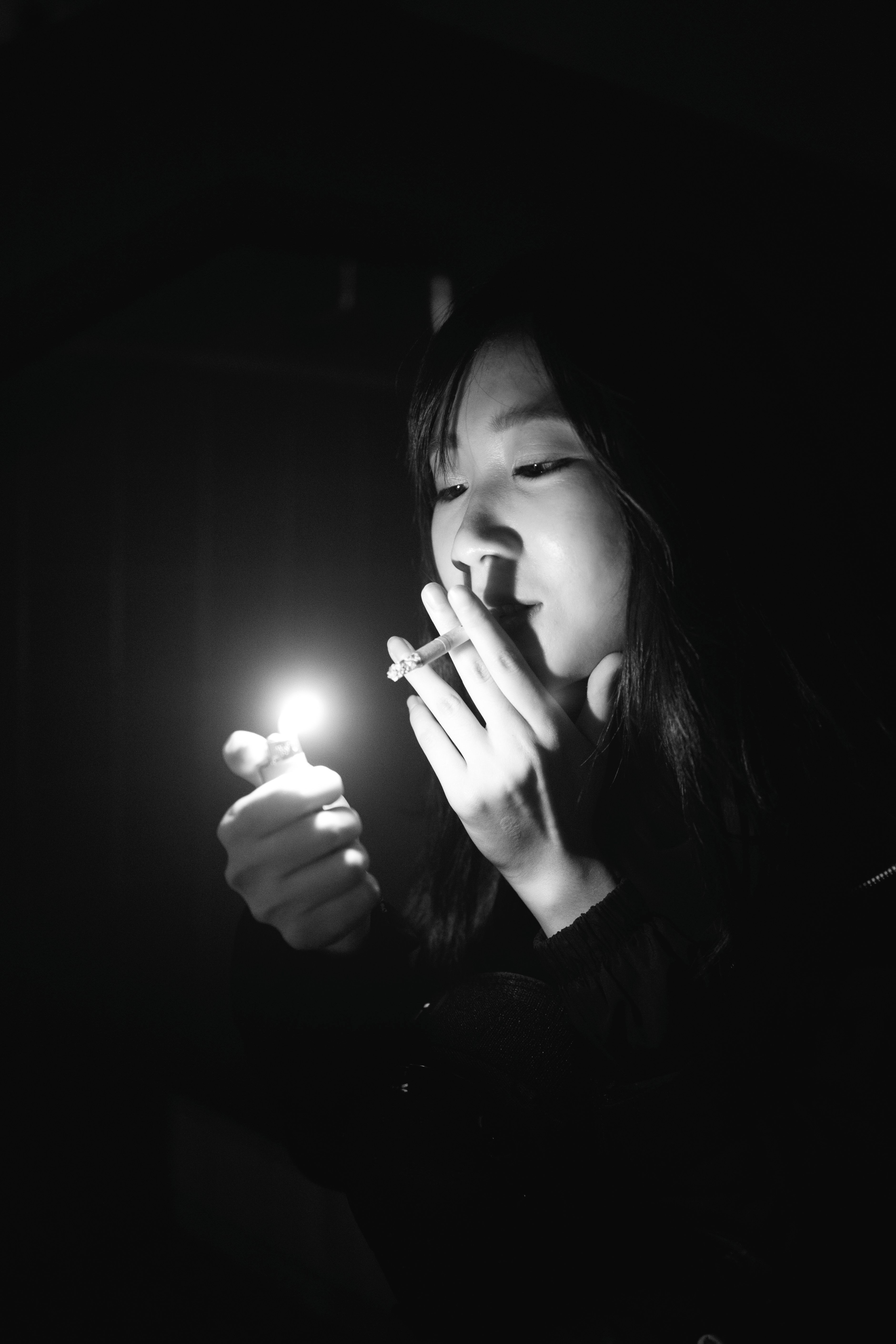 Black and White Shot of a Woman Lighting Up her Cigarette · Free Stock ...
