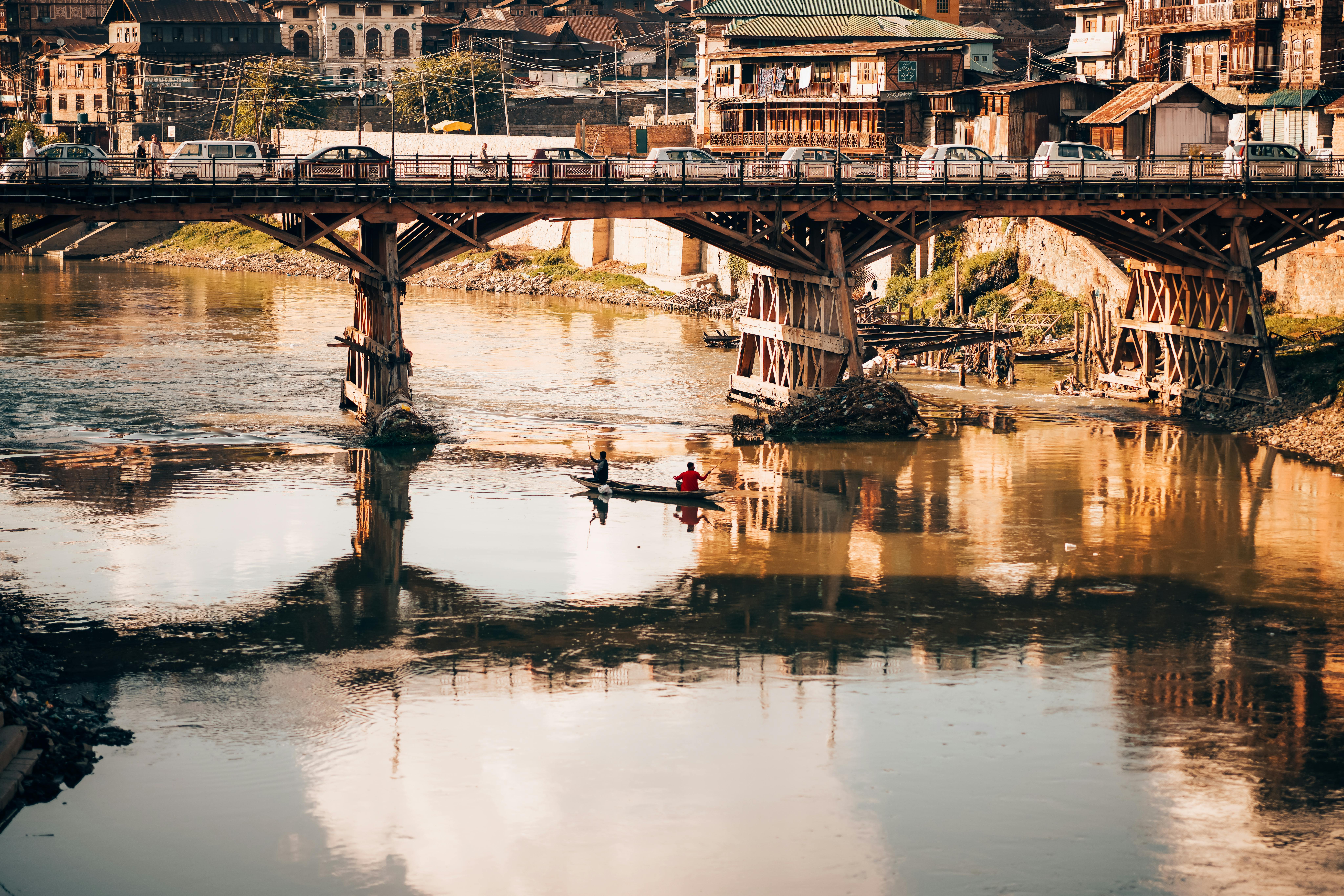 People Riding on Boat on River Under Bridge · Free Stock Photo