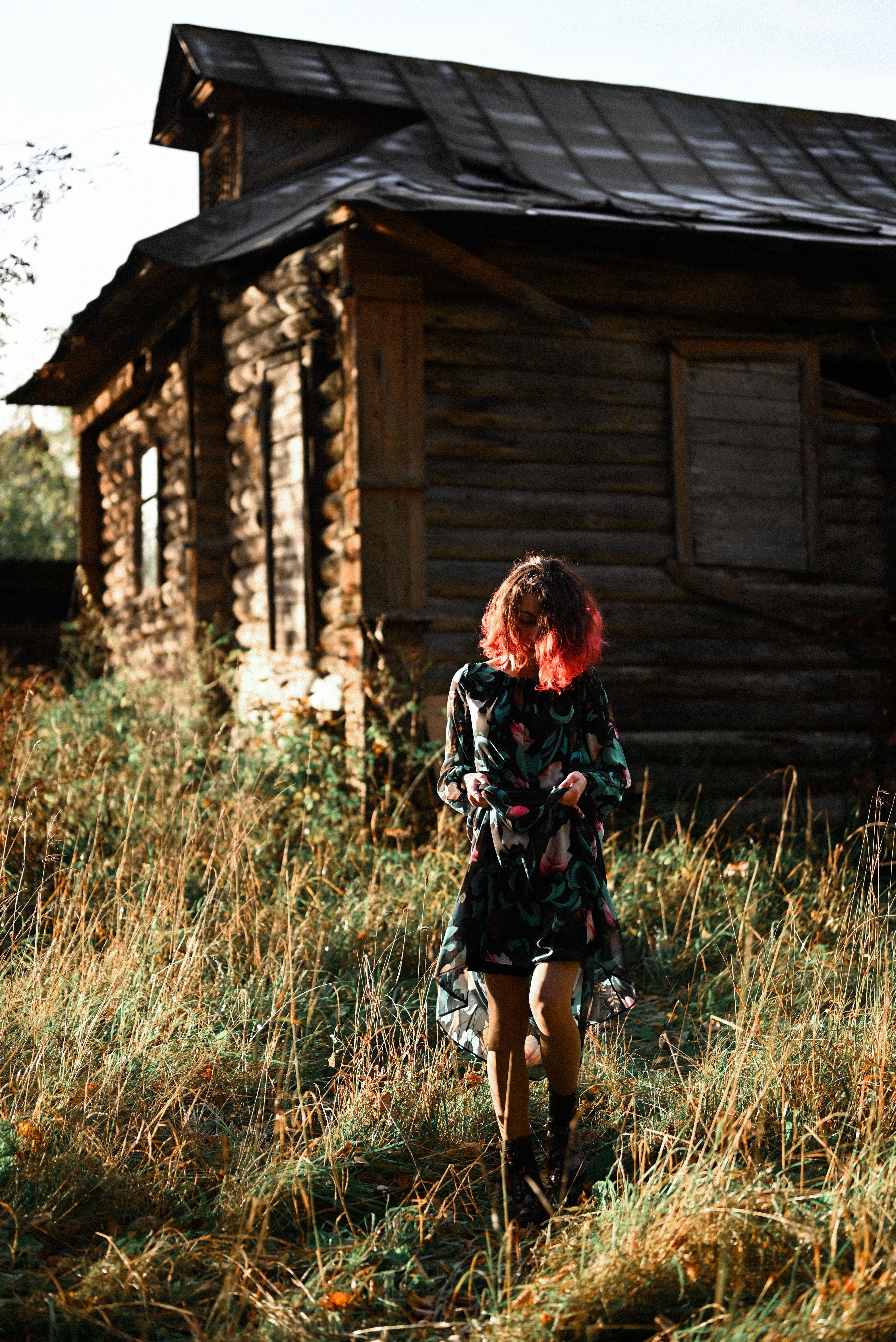 A Woman Outside a Wooden Cabin · Free Stock Photo