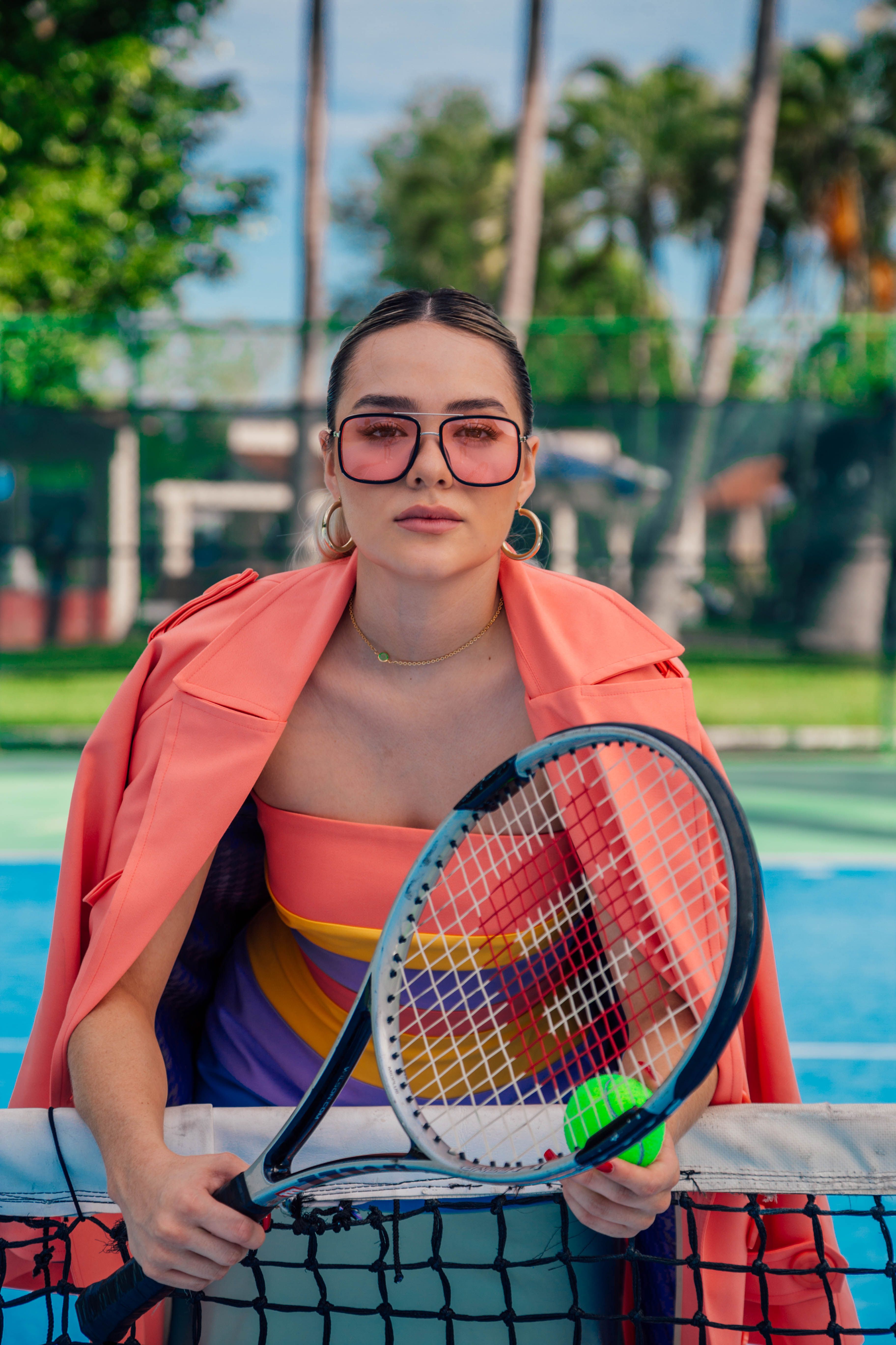 A Low Angle View of a Female Model Holding a Tennis Racket Towards ...