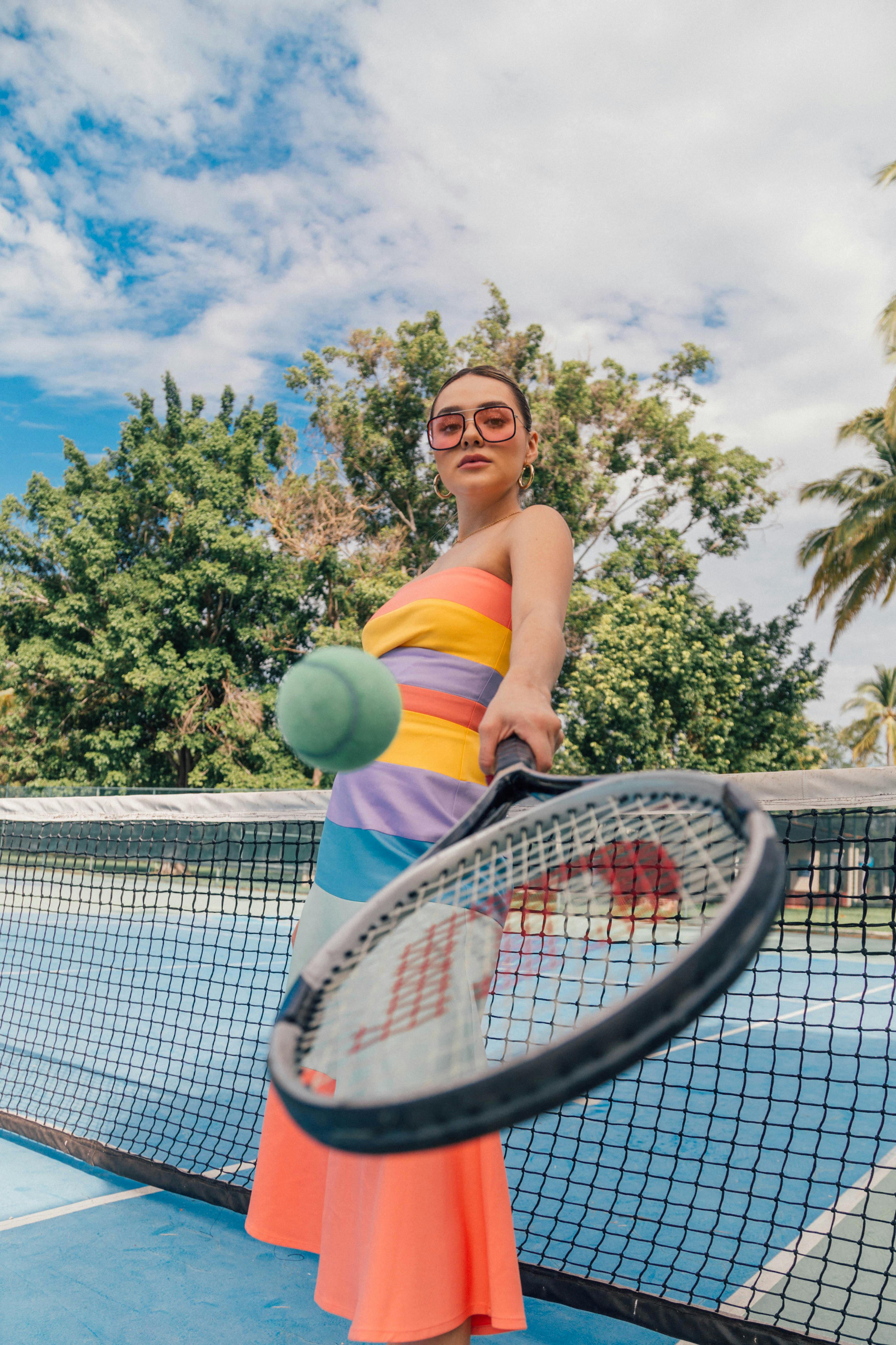 A Low Angle View of a Female Model Holding a Tennis Racket Towards ...