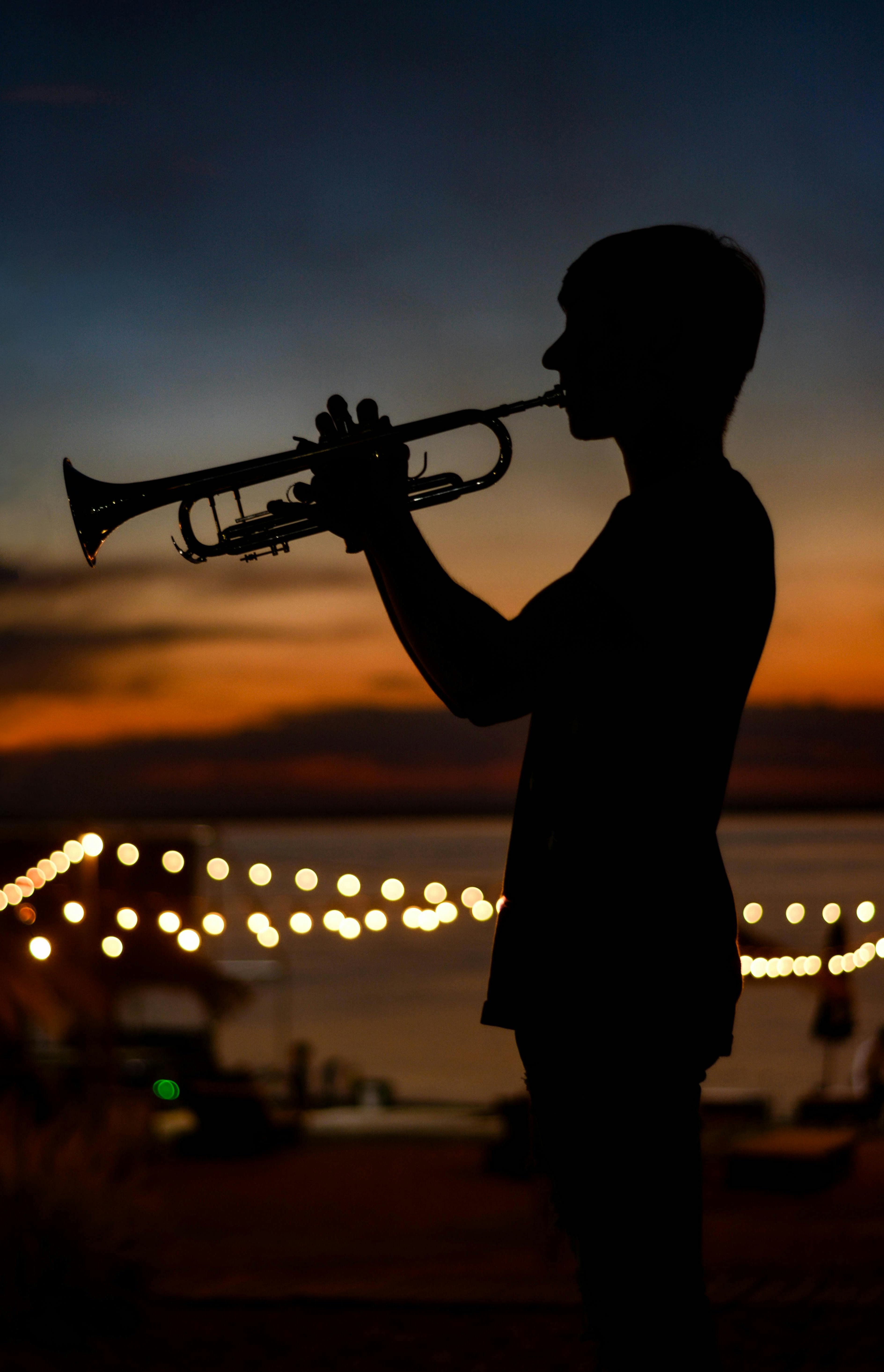 Silhouette of a Person Playing Trumpet · Free Stock Photo