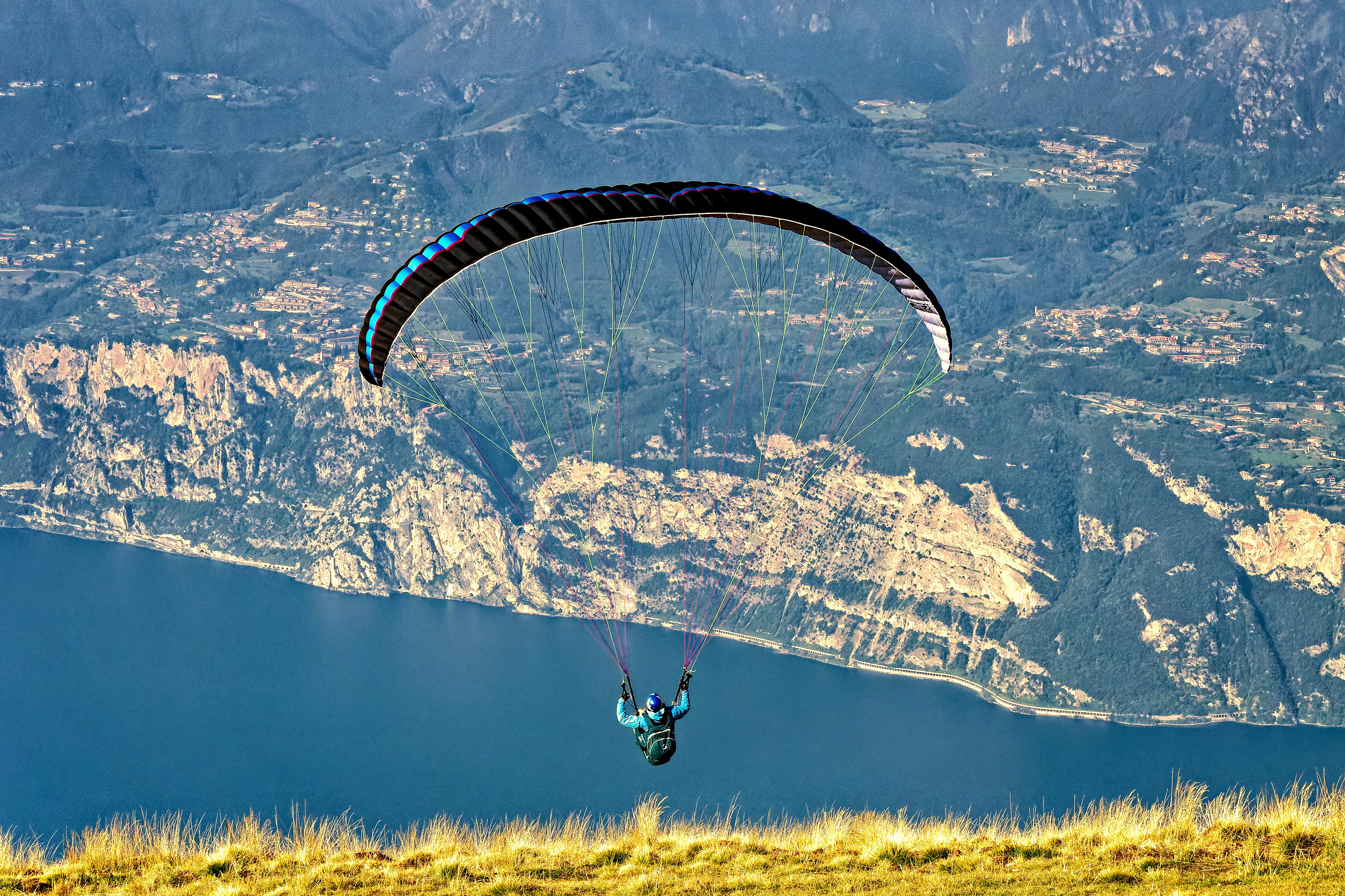 Panorama Photo of a Person Parachuting Above Volcano Lake during ...