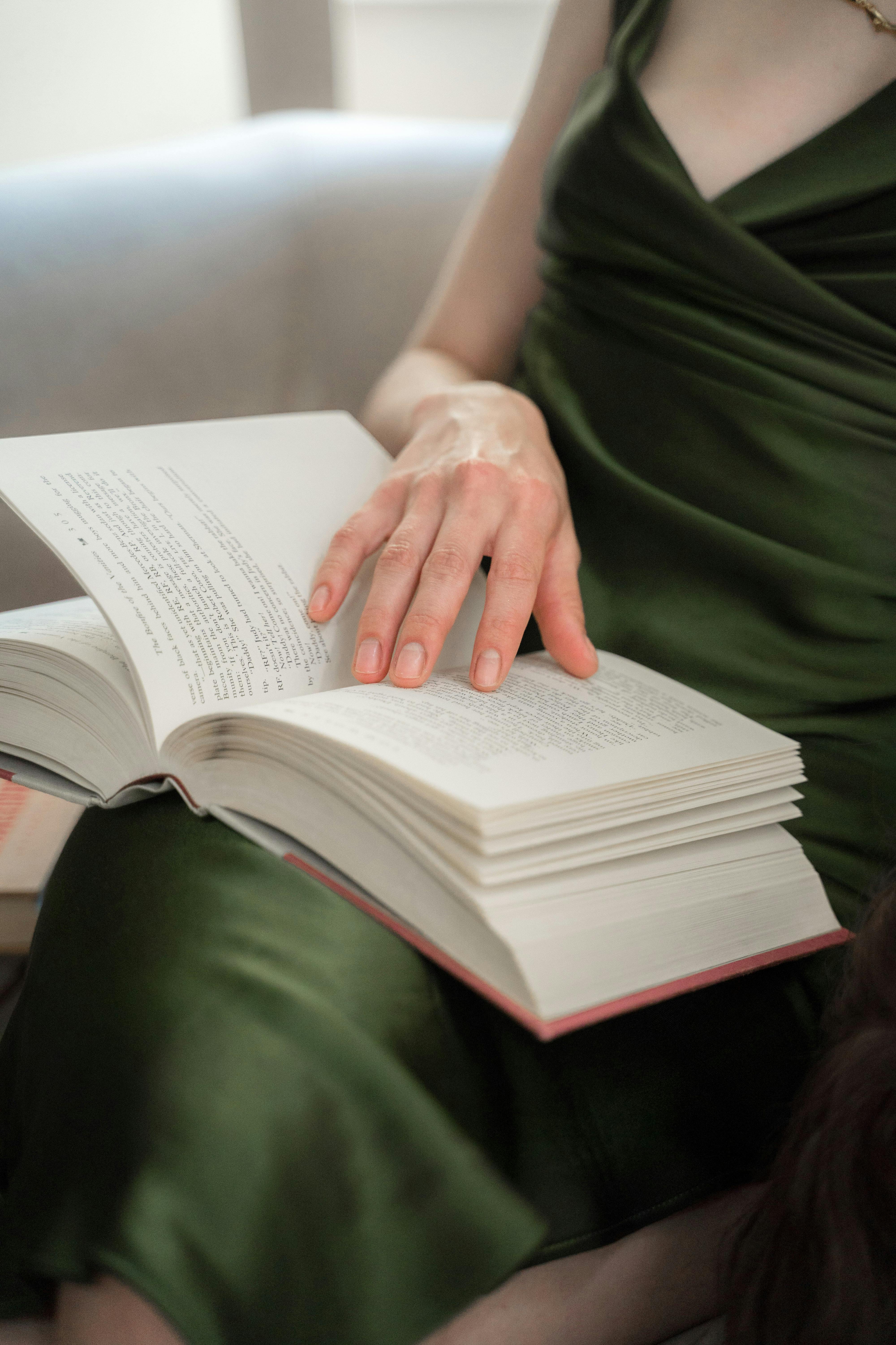 Womans Hand on Book · Free Stock Photo