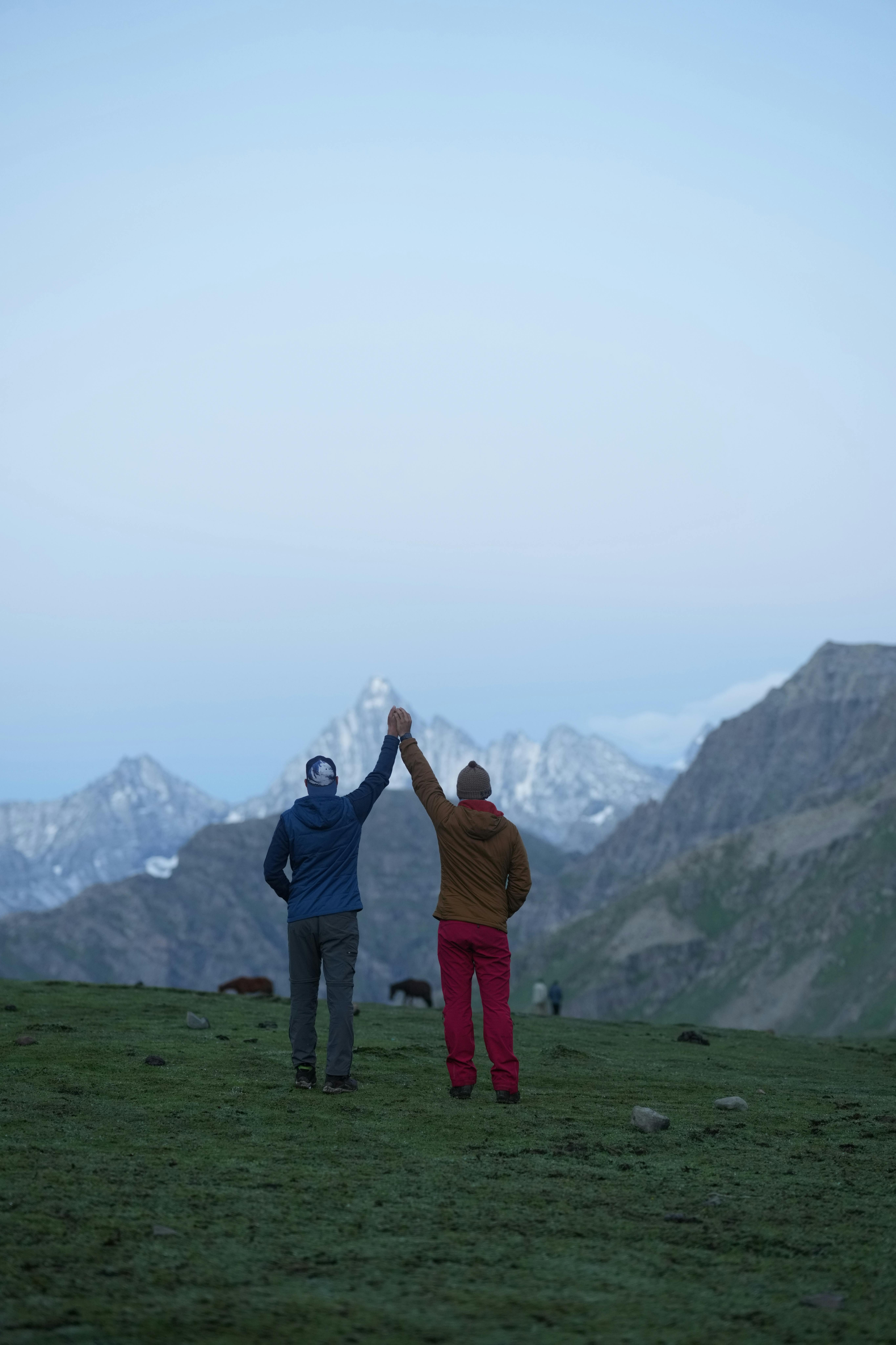 Two People Holding Hands and Raising it While in the Mountains · Free ...