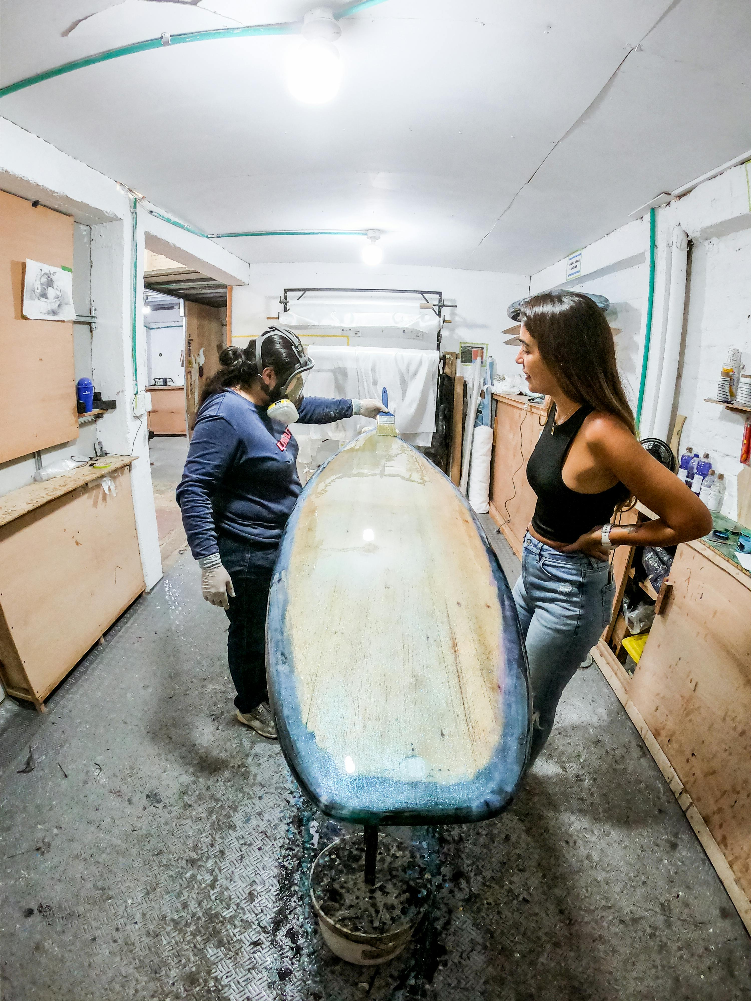 Worker Painting Surfboard in Workshop · Free Stock Photo