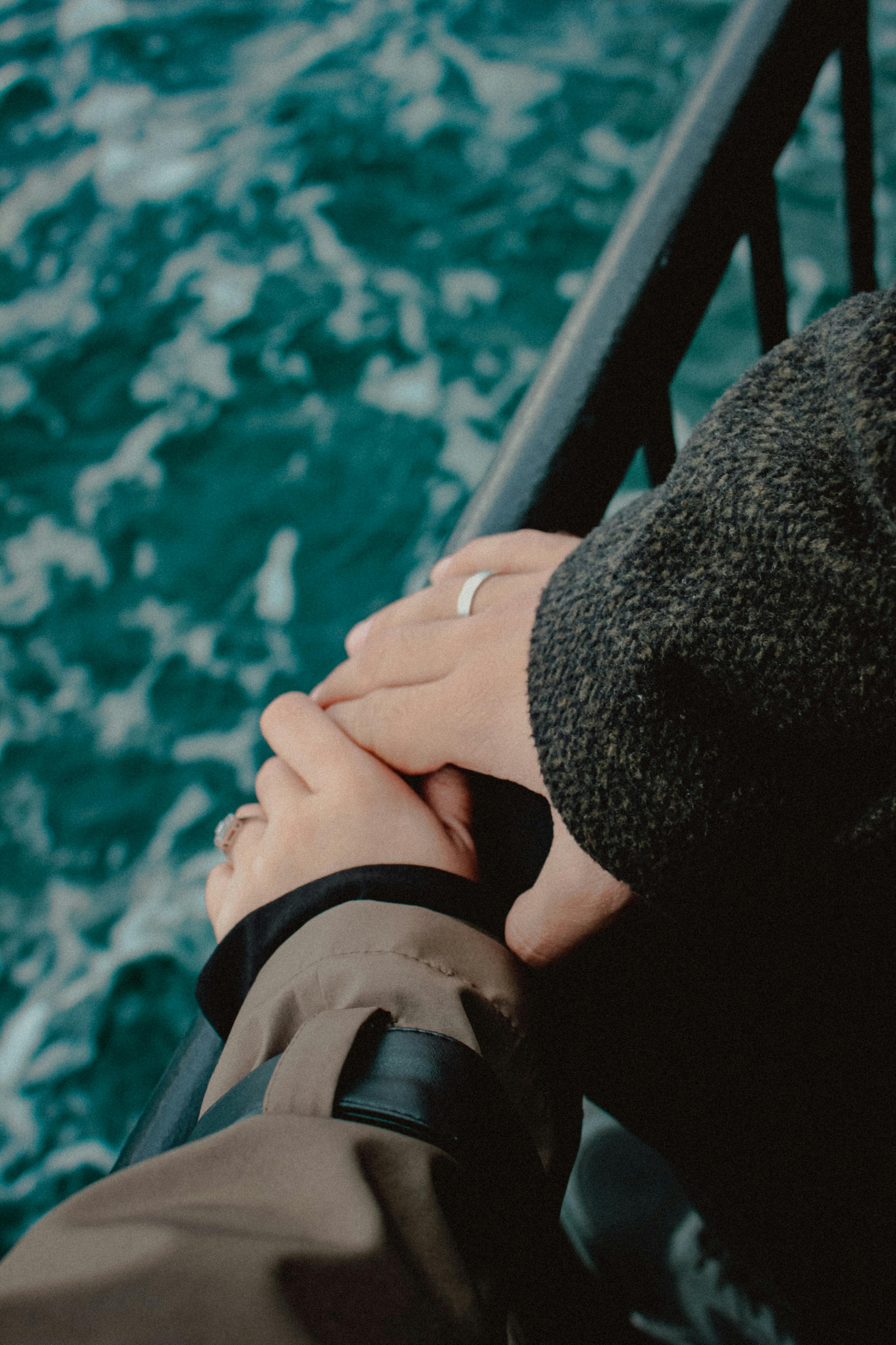 Hands Holding onto Iron Rail Touching · Free Stock Photo