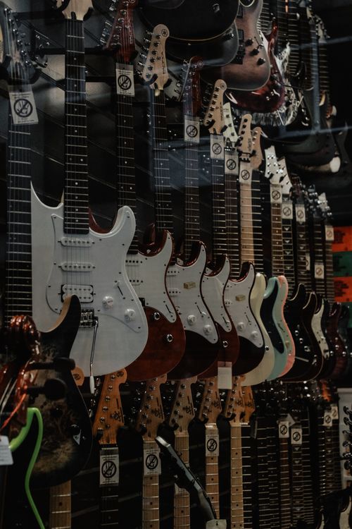 Assorted Electric Guitars Hanging · Free Stock Photo