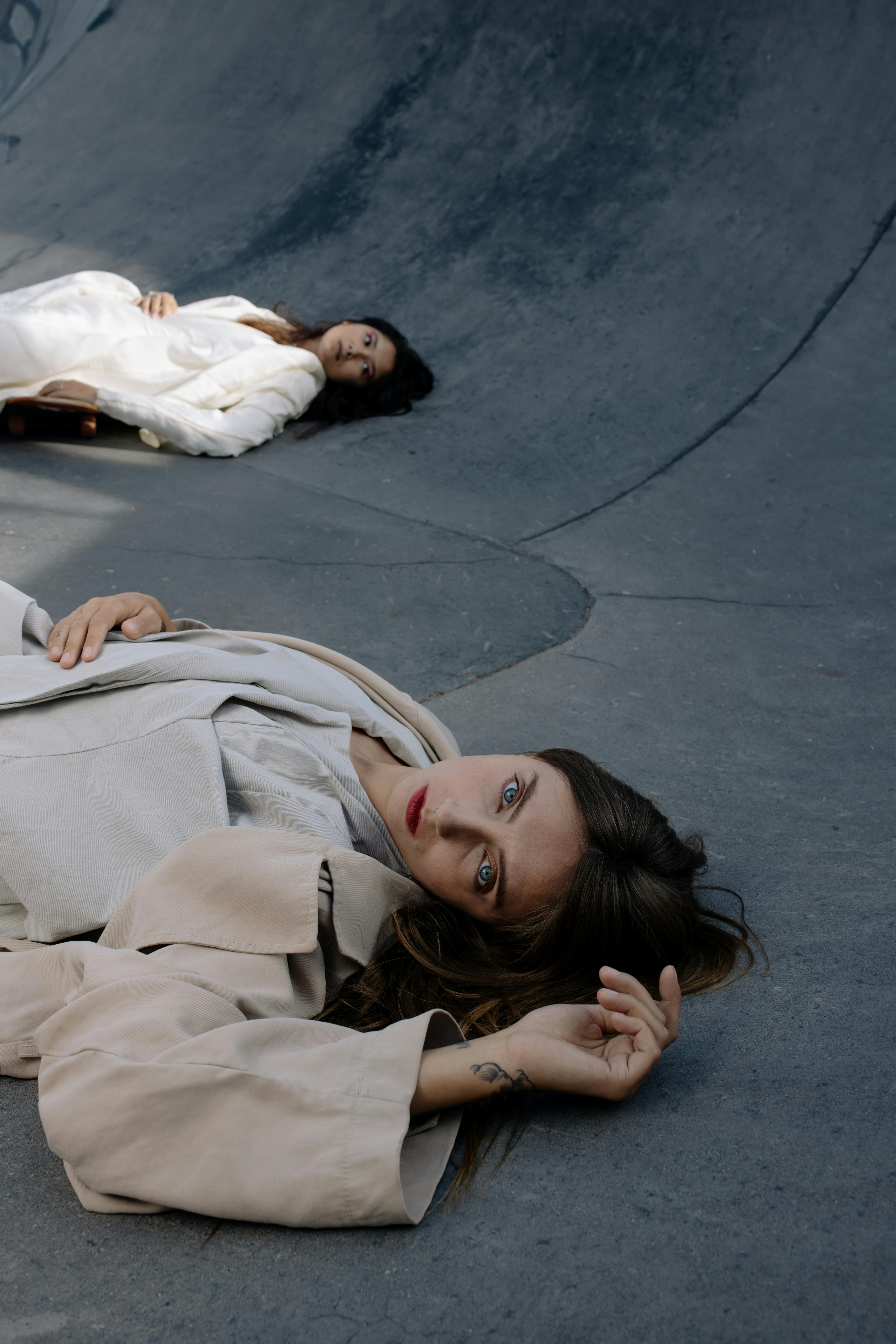 Fashion Models Lying Down in Skate Park · Free Stock Photo