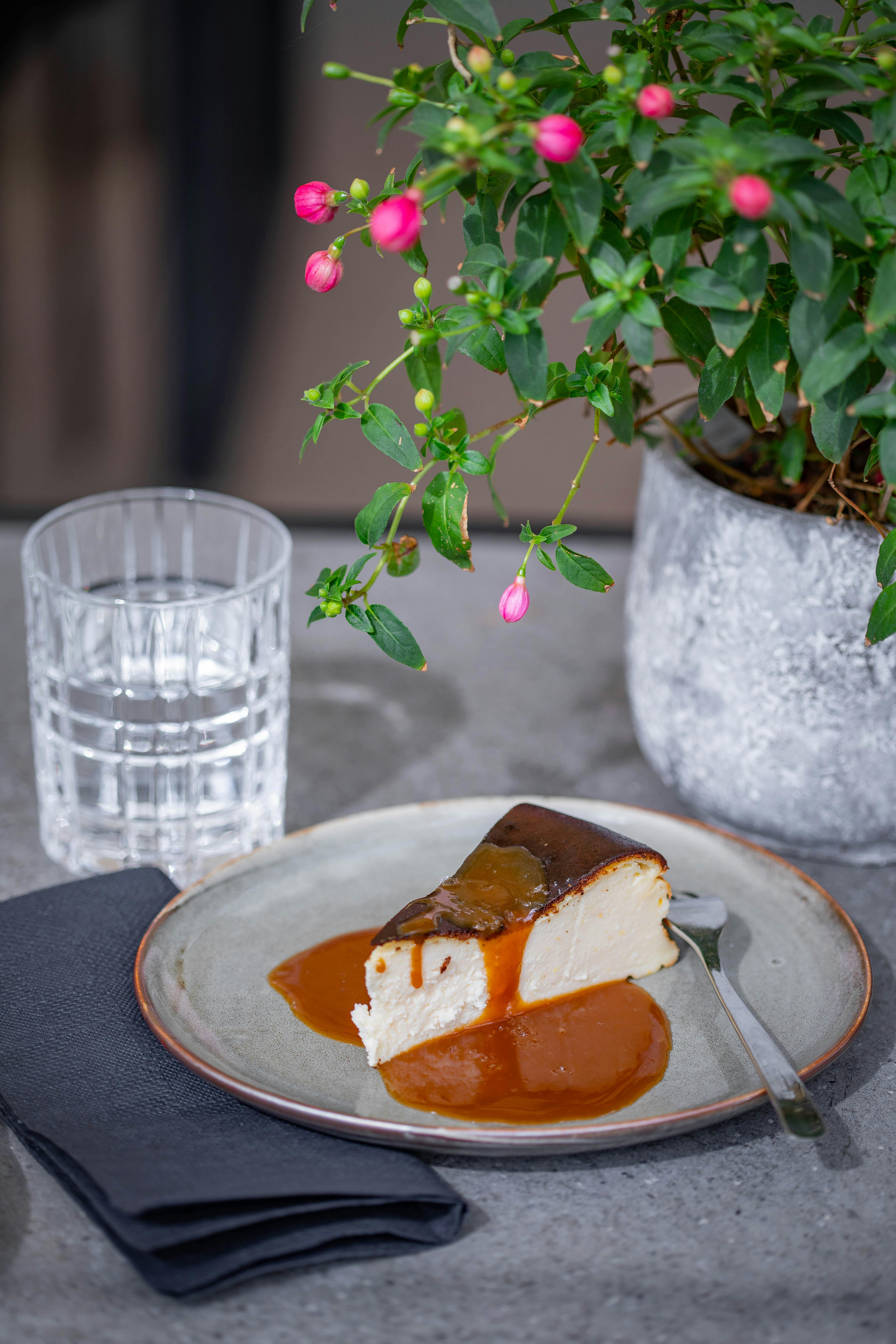 Dessert on Plate and Flowers in Vase · Free Stock Photo