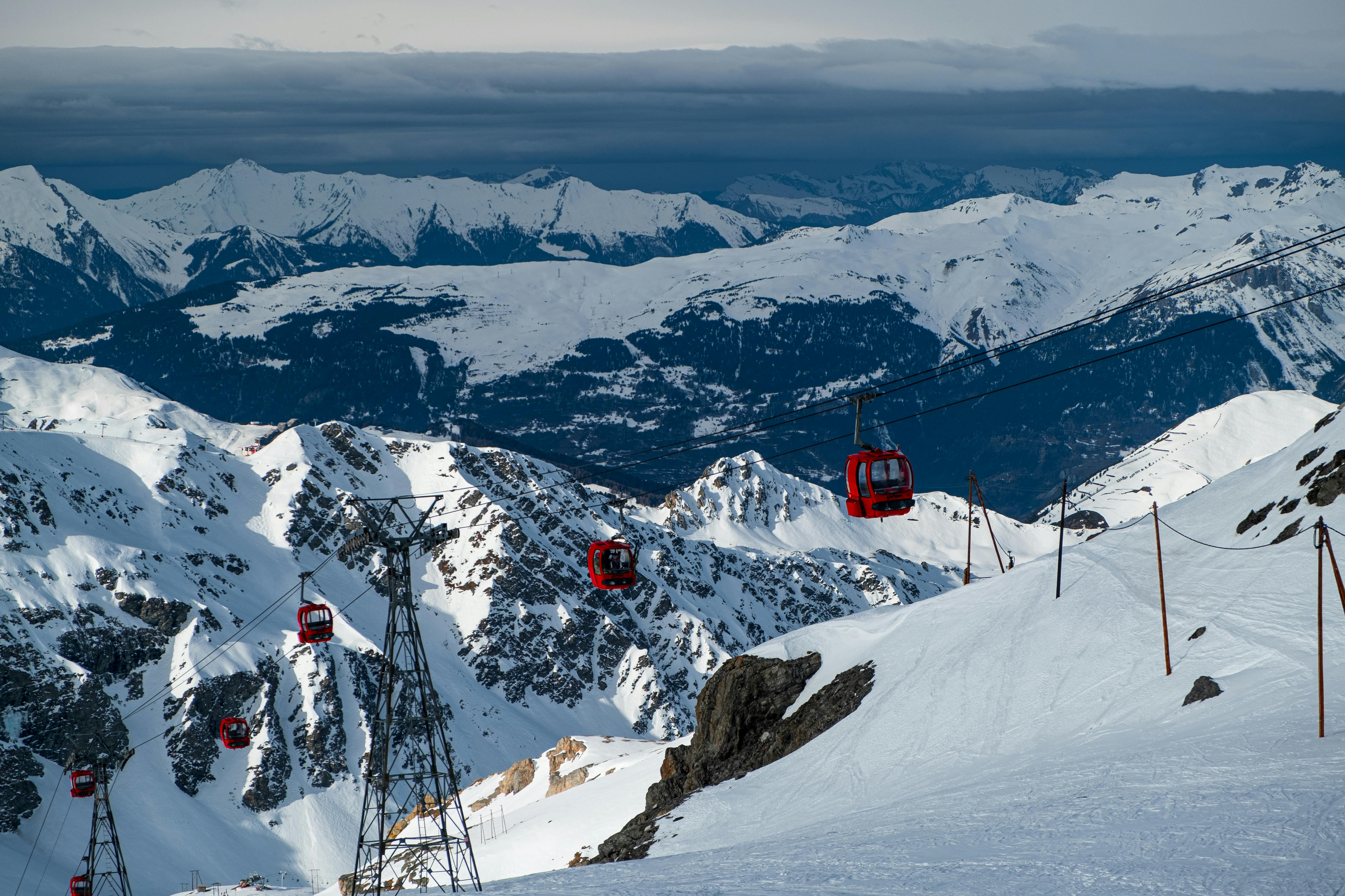 Red Cable Cars over Snow Covered Mountain · Free Stock Photo