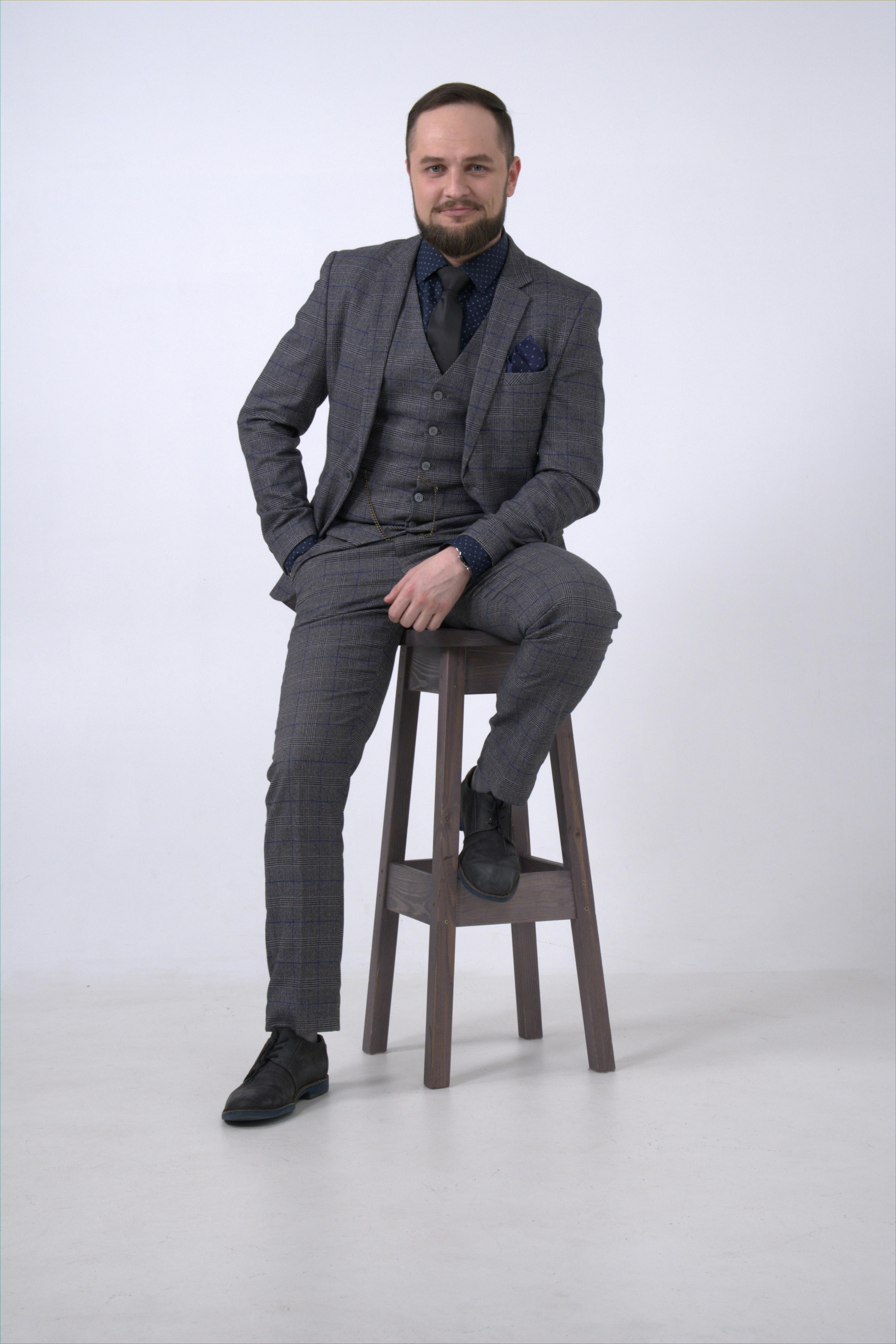 Man in Gray Suit Sitting on Brown Wooden Seat · Free Stock Photo