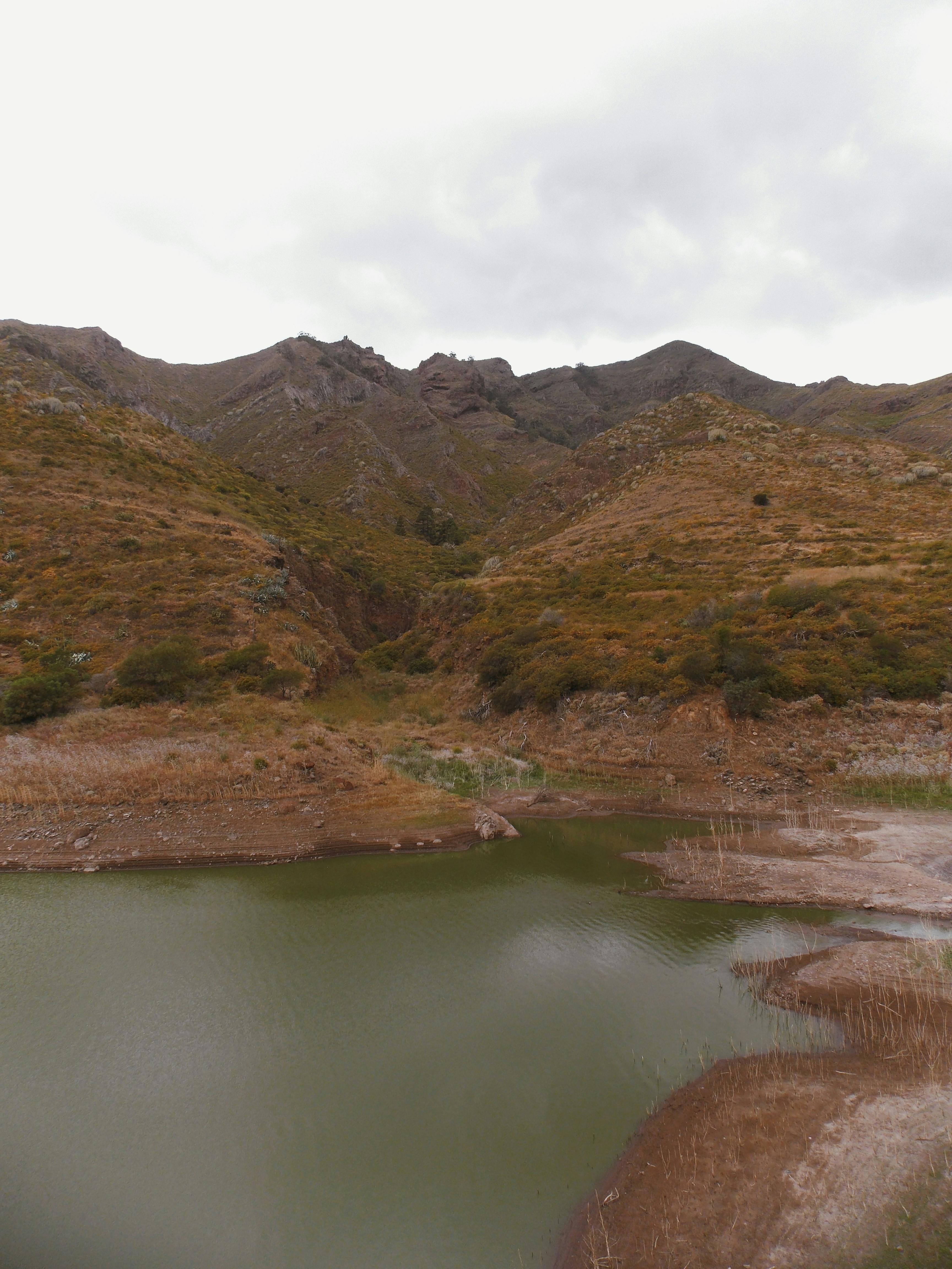 A Lake at the Base of a Hill · Free Stock Photo