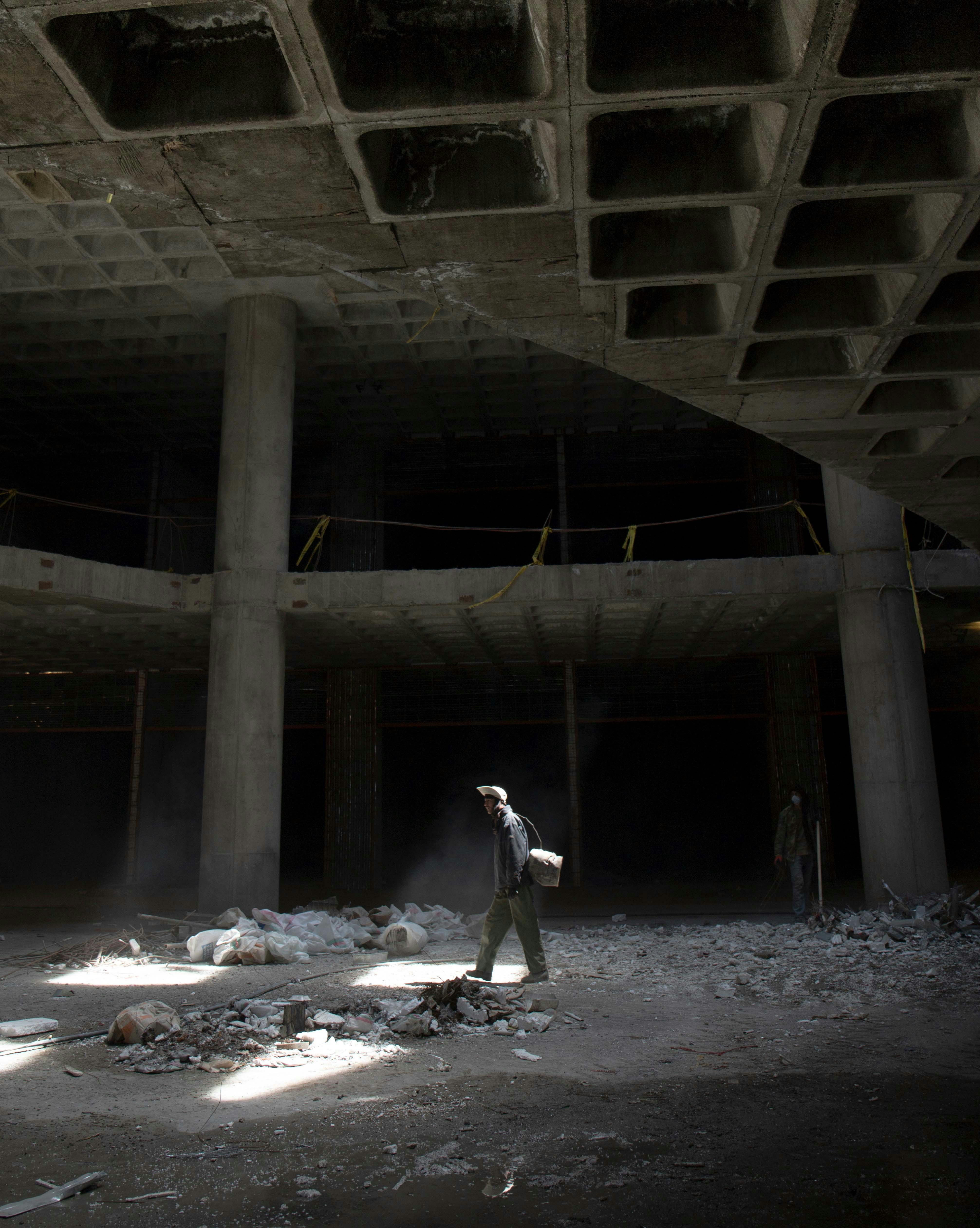 Person Walking Inside an Abandoned Building · Free Stock Photo