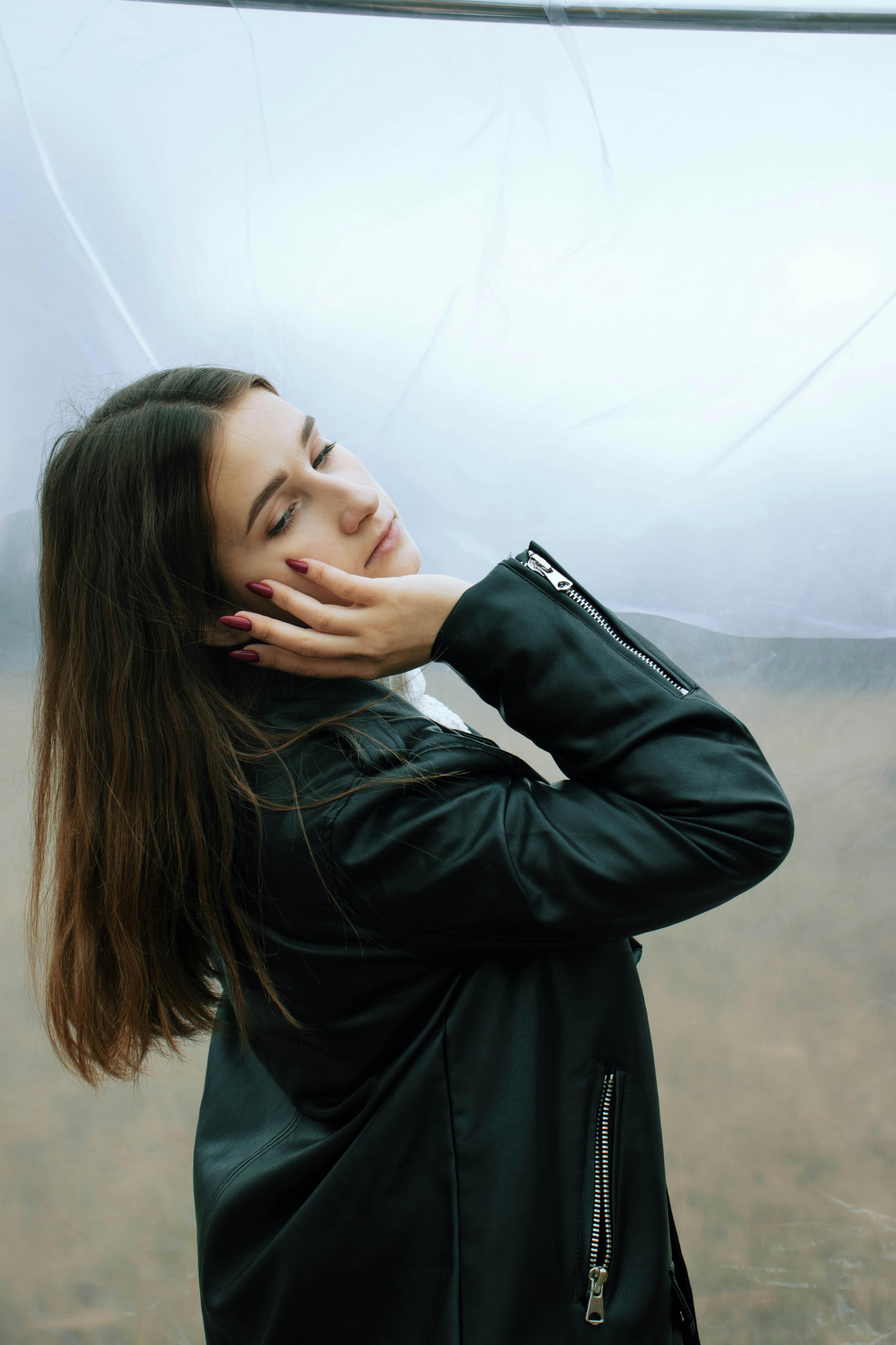 Young Woman in Hooded Jacket Eating Noodles at a Cafe · Free Stock Photo