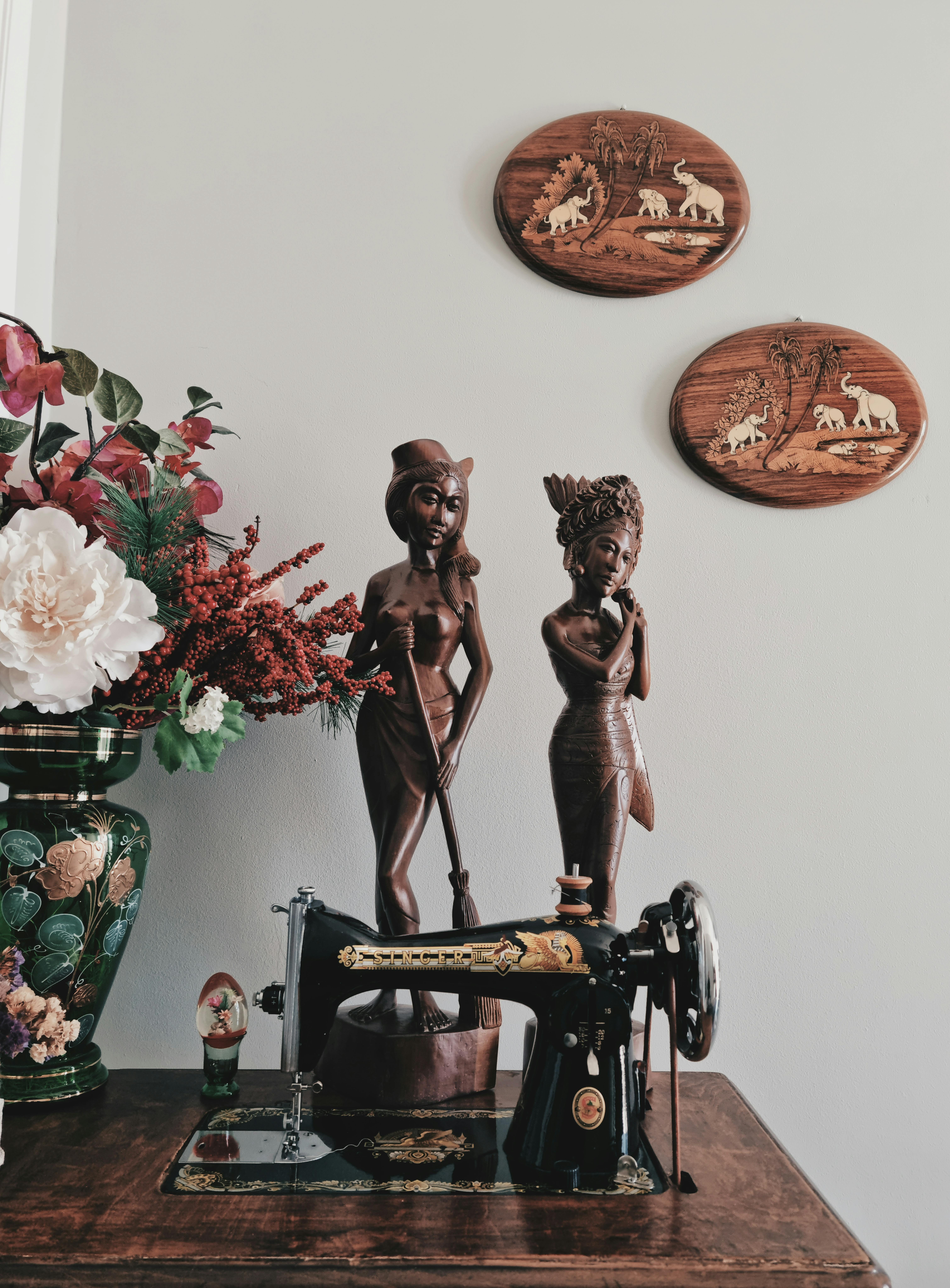 Wooden Figurines Near a Vintage Sewing Machine · Free Stock Photo