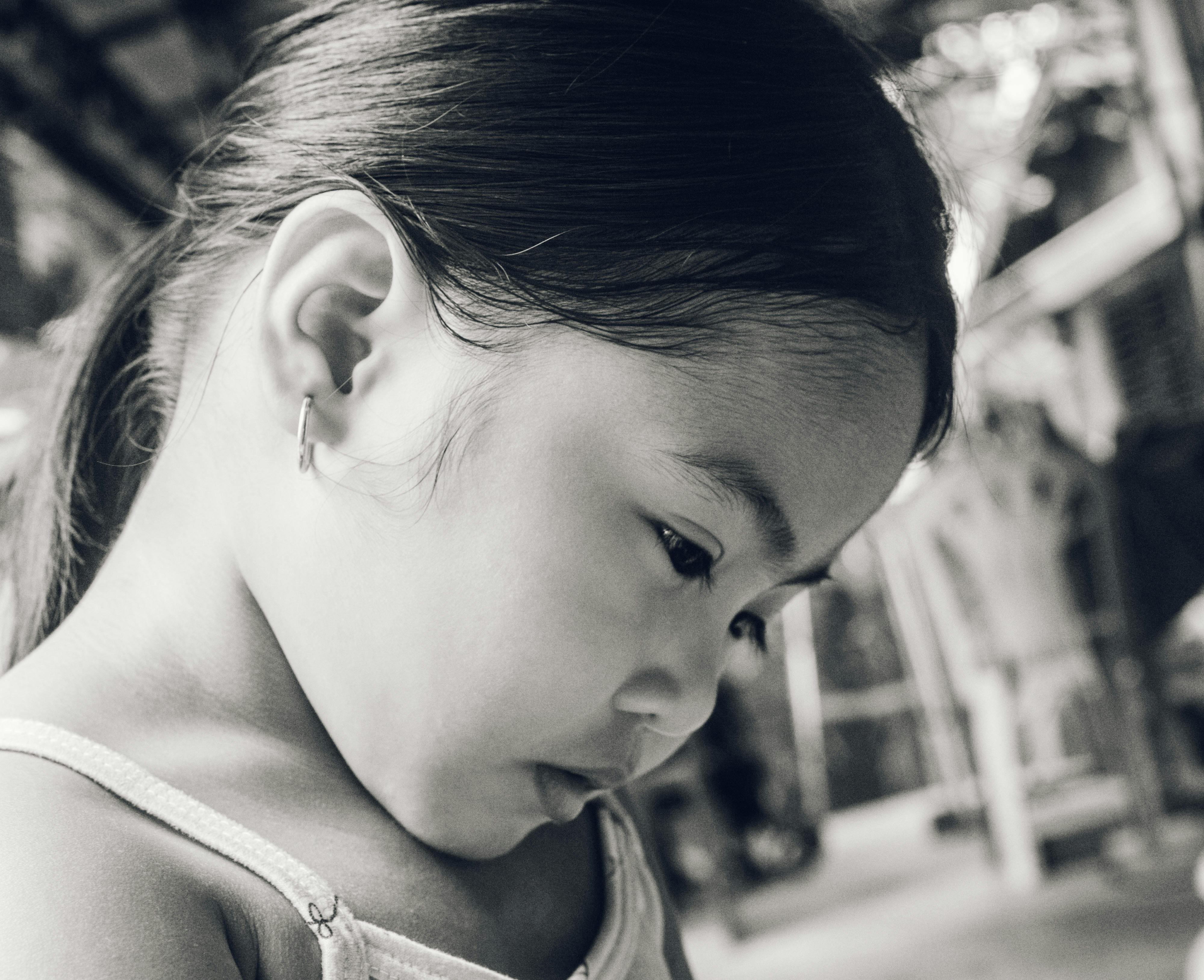 A Grayscale of a Girl Wearing Earrings · Free Stock Photo