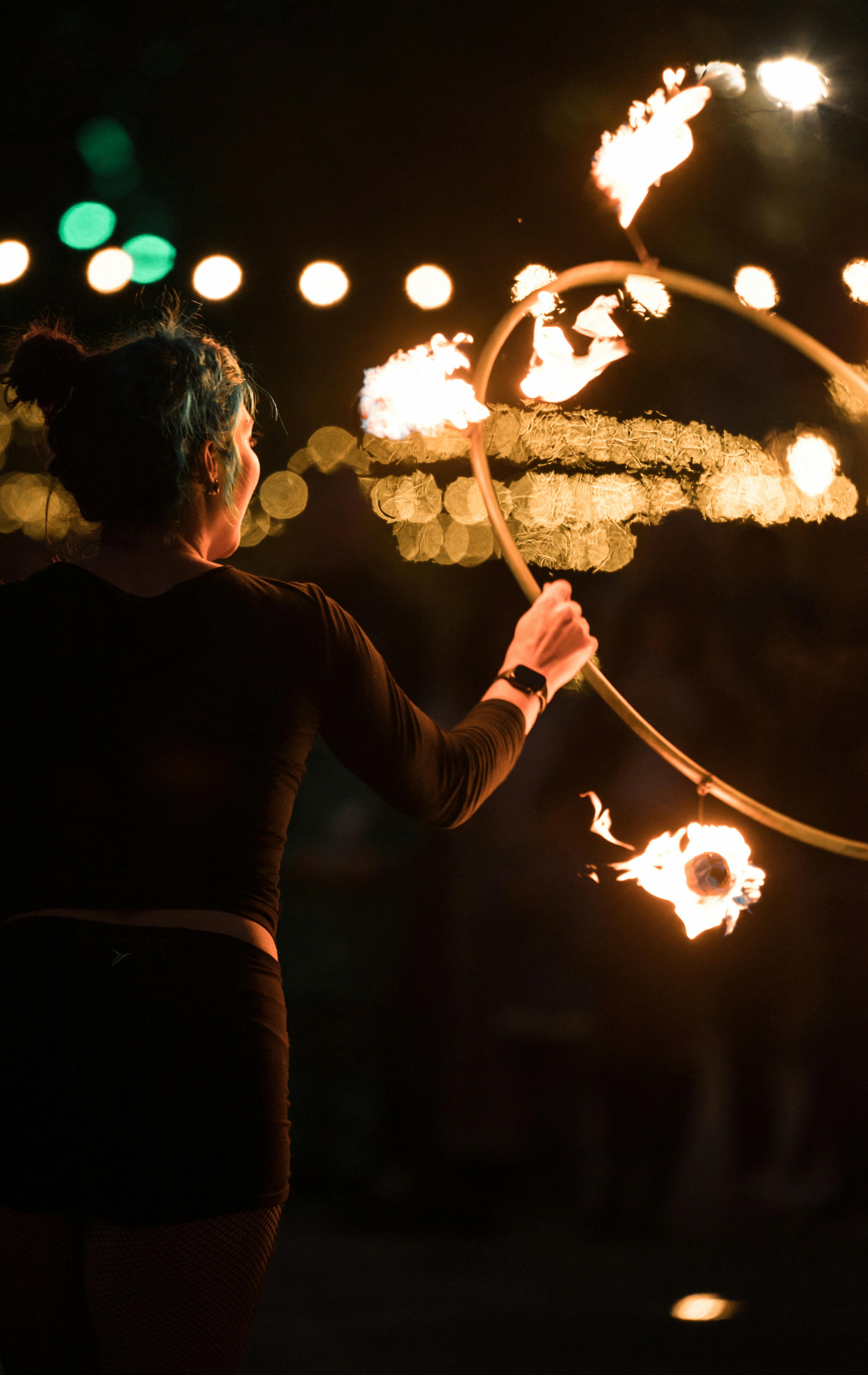 Fire artist waving torch and smiling · Free Stock Photo