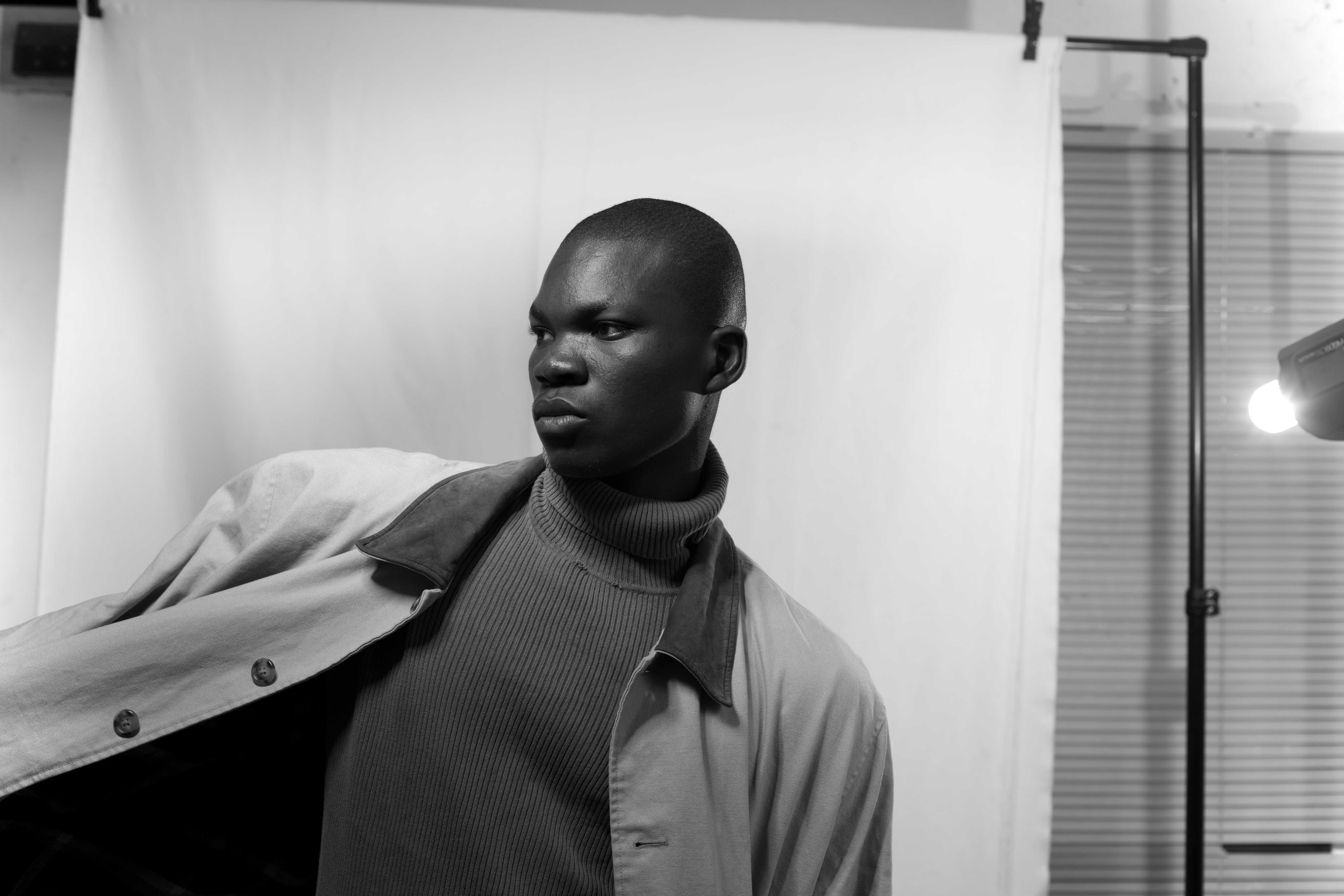 Man Posing with His Jacket Thrown Over His Shoulder · Free Stock Photo