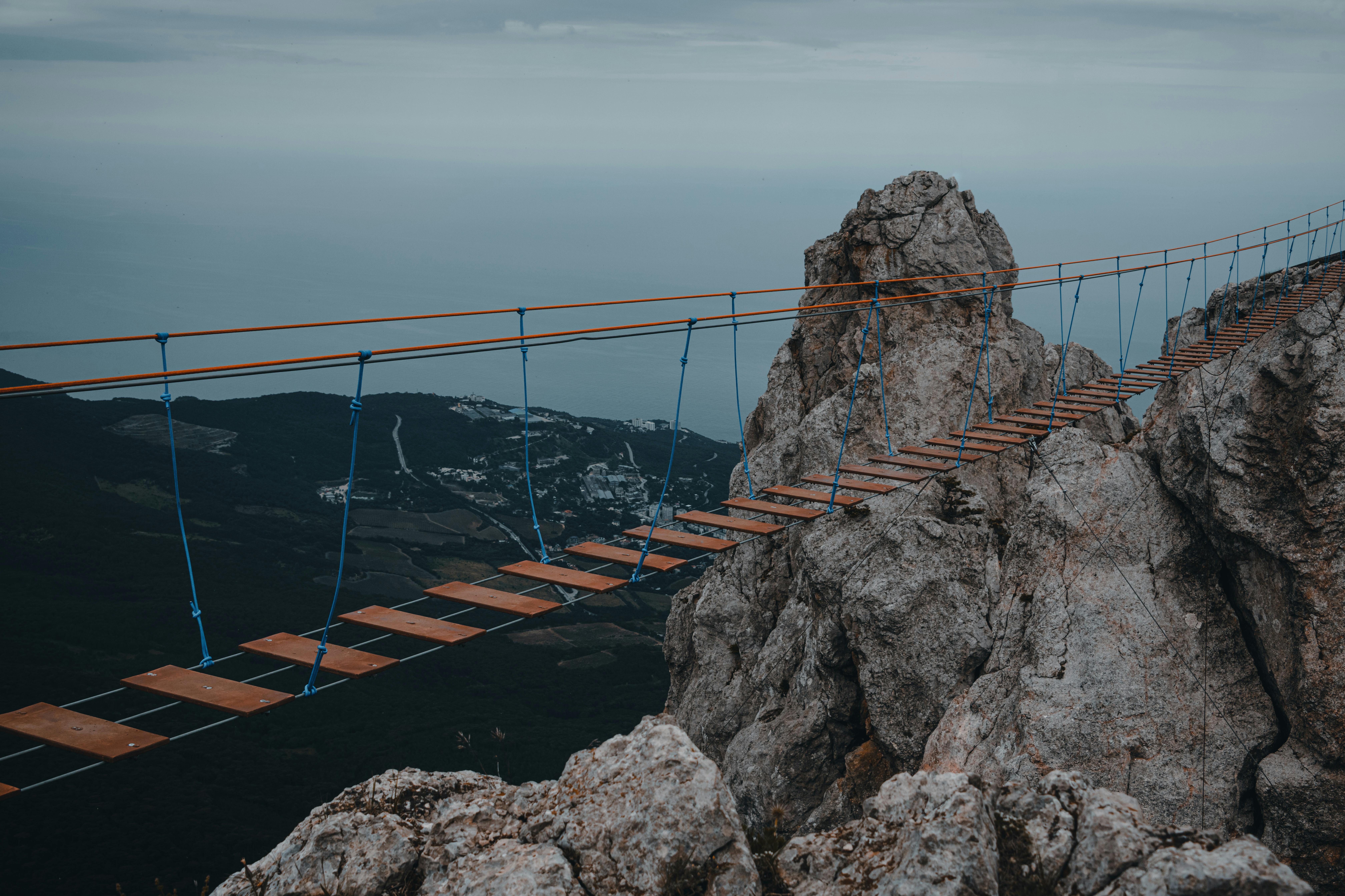 Wooden Hanging Bridge Over Rock Formations · Free Stock Photo