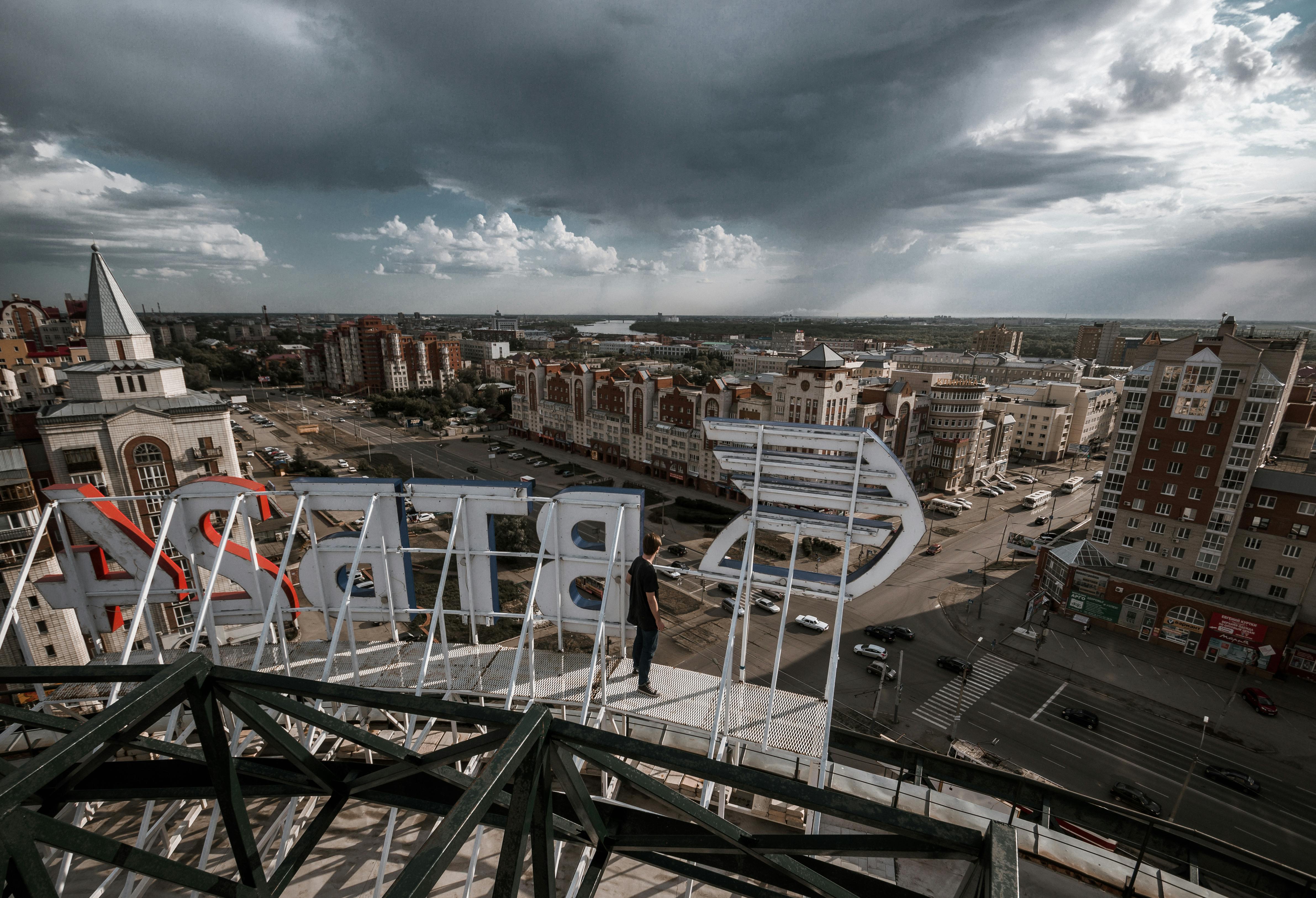 Man Standing on a Rooftop of a Building in City · Free Stock Photo