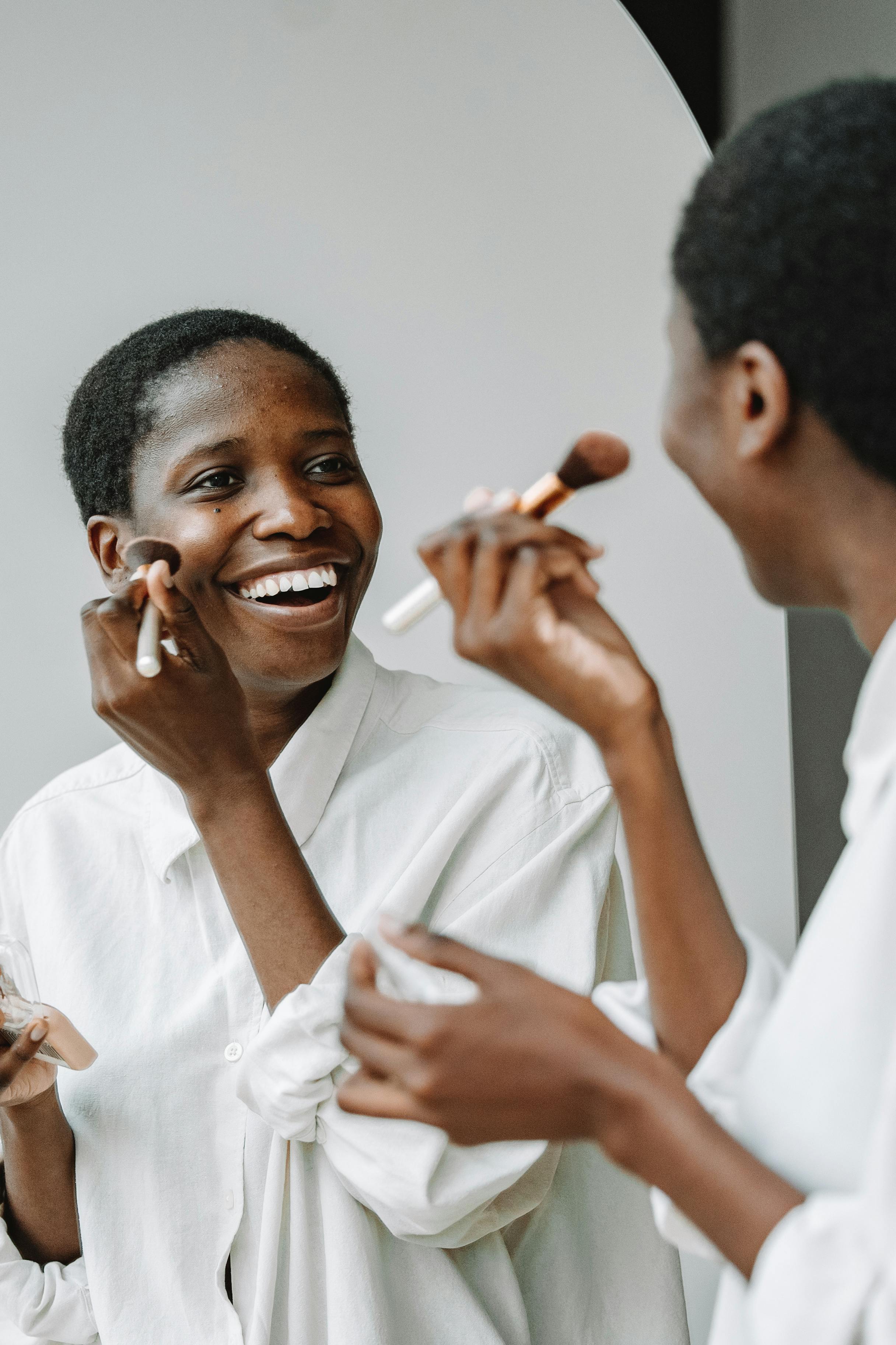 Reflection of a Woman Putting Makeup · Free Stock Photo