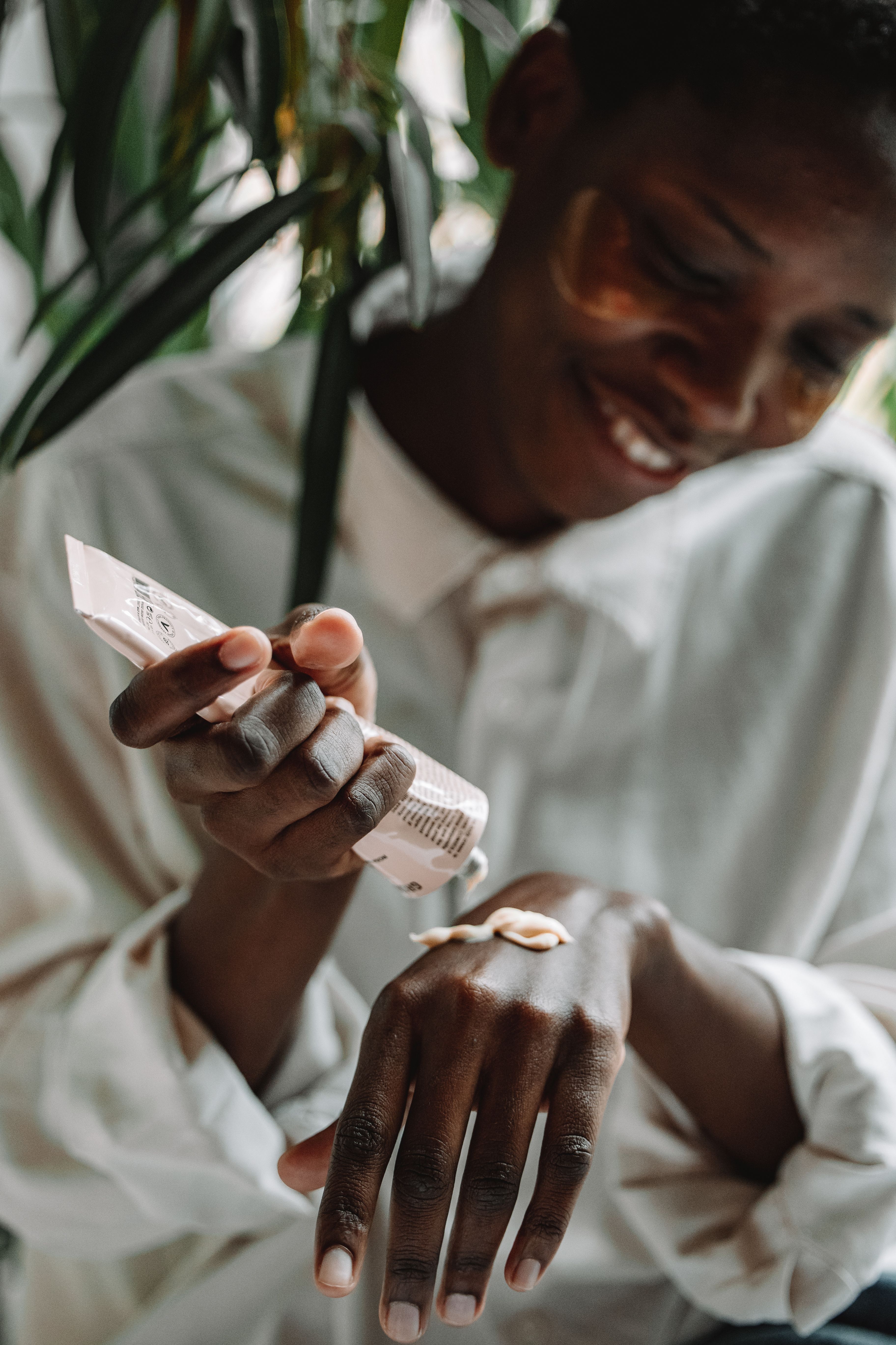 A Person Putting Cream on their Hand · Free Stock Photo
