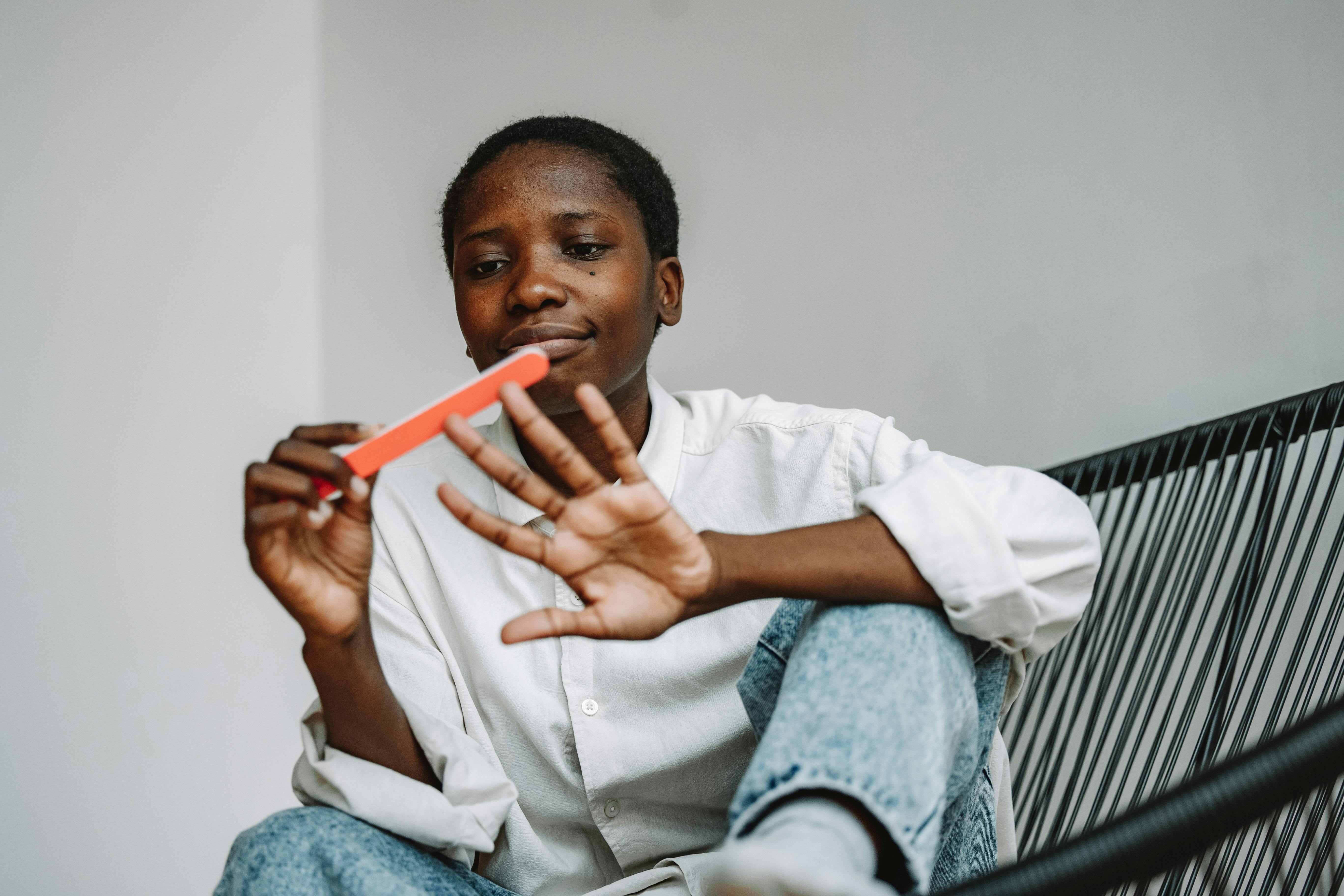 Woman Using a Nail File · Free Stock Photo