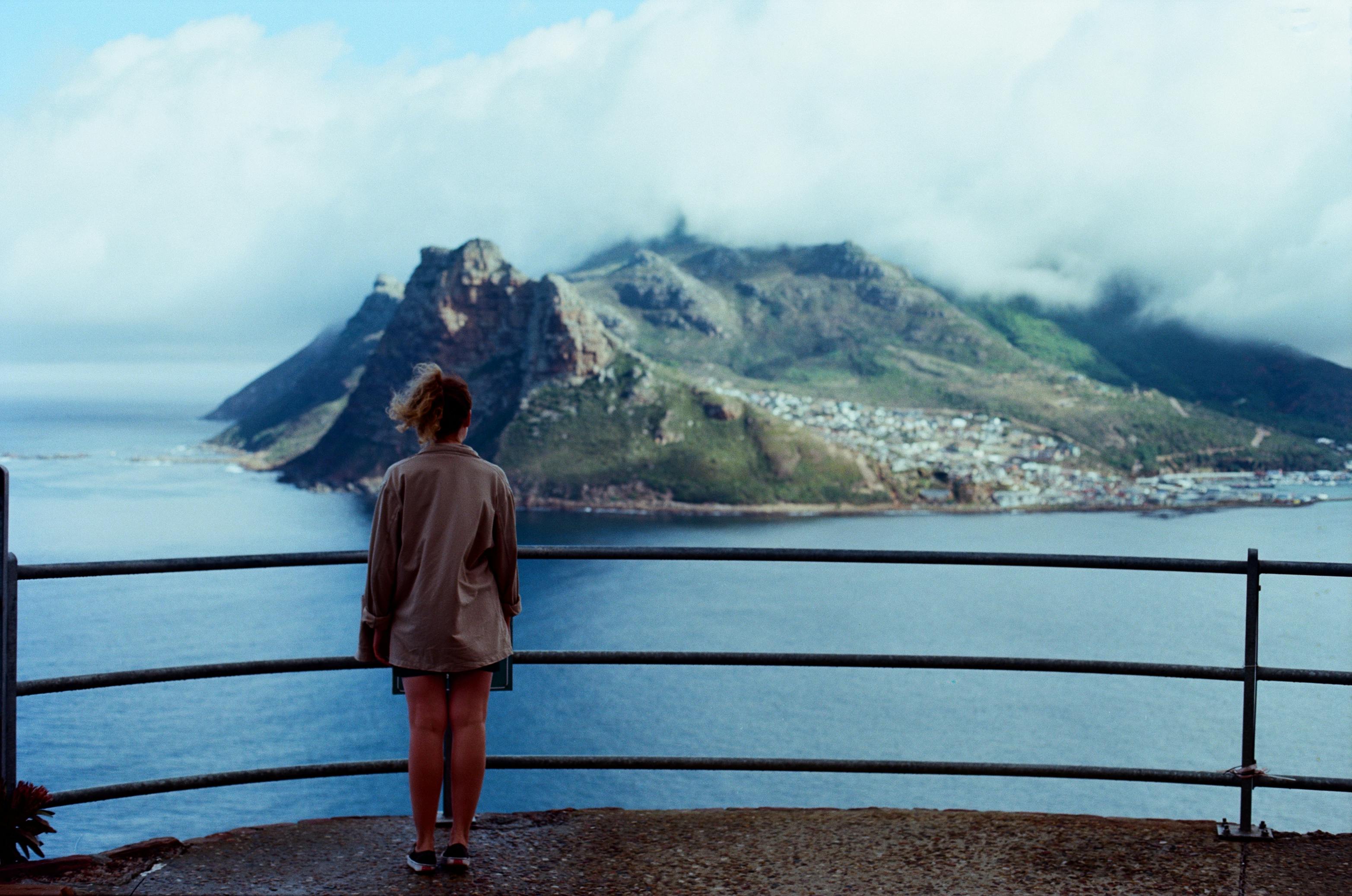 Man in White Shirt and Black Pants Standing beside Silver Railing ...