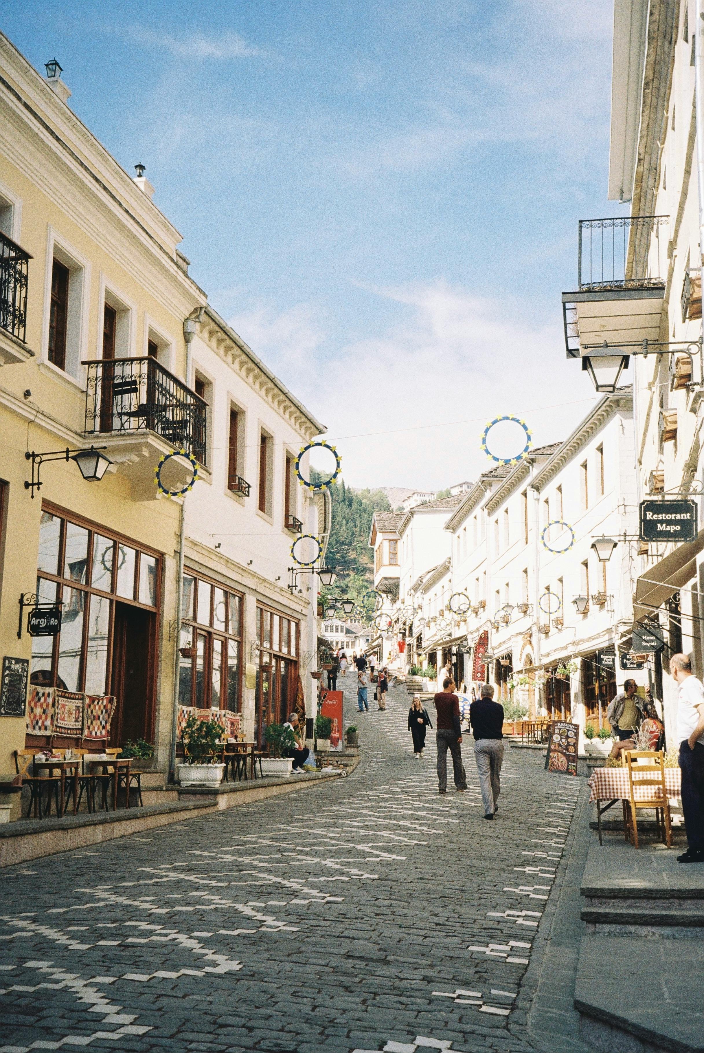 People Walking on the Street Between Buildings · Free Stock Photo