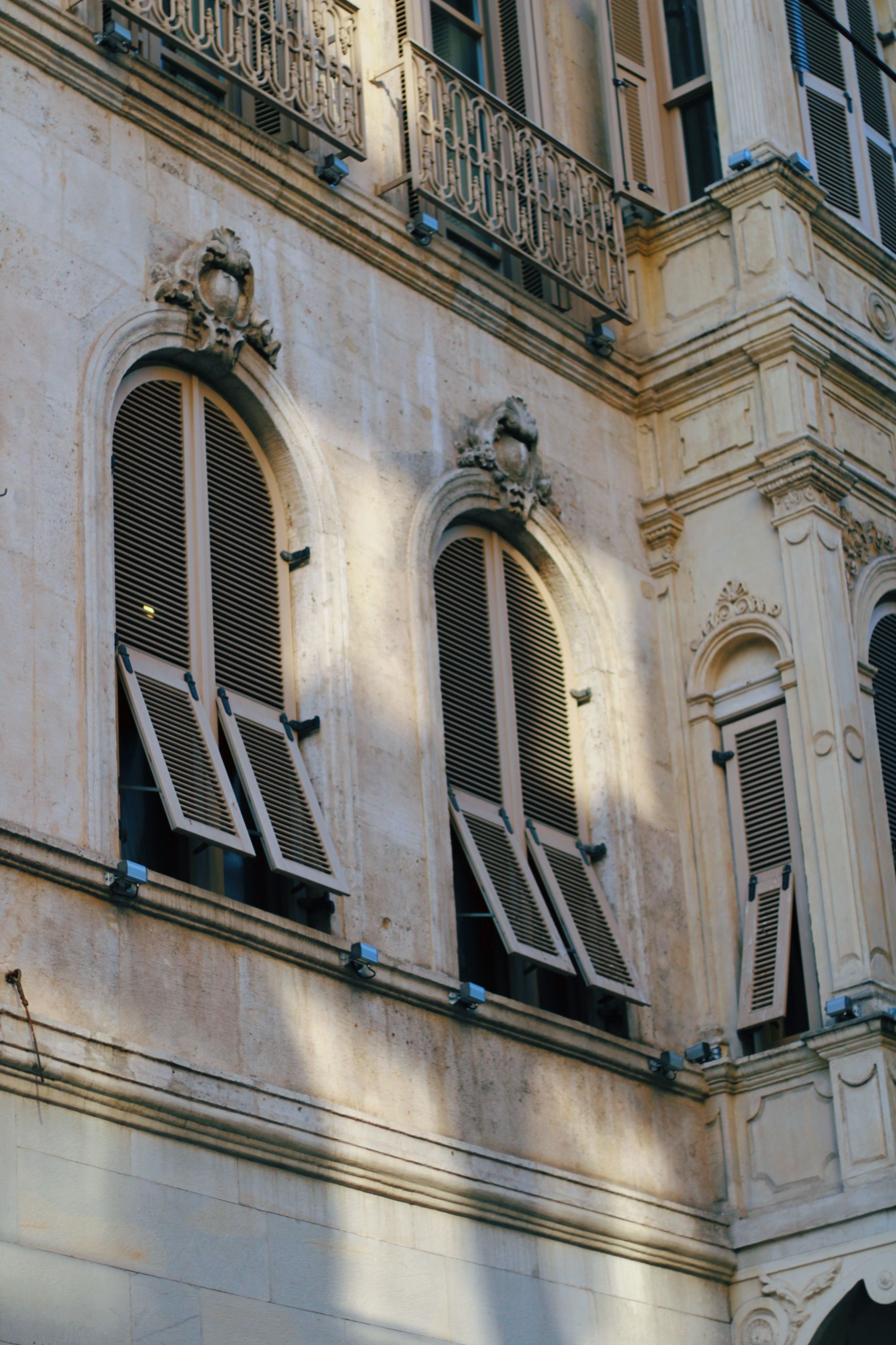 Man Sitting on a Window Ledge of a Historical Building · Free Stock Photo