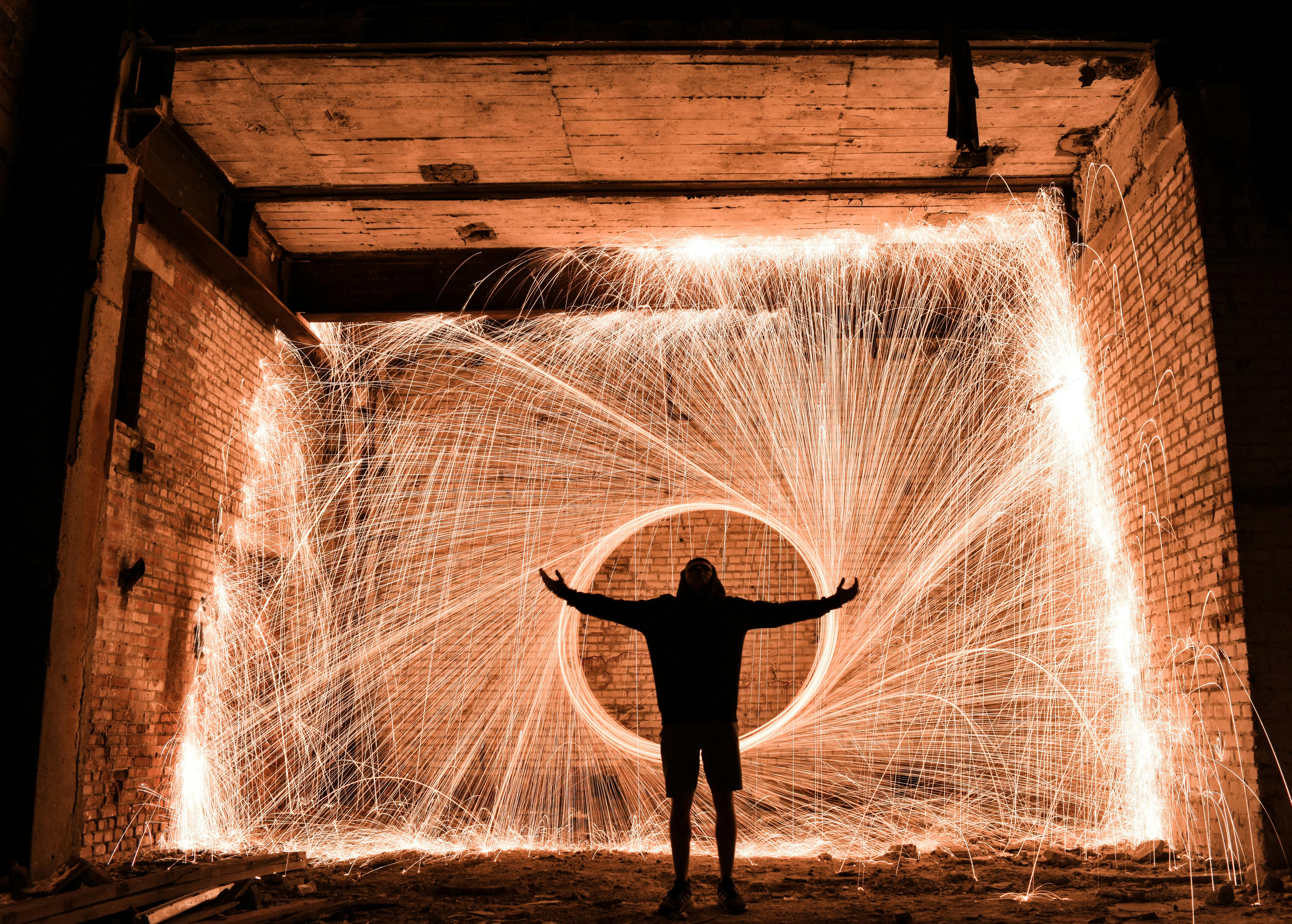 Silhouette of a Person Standing in Front of the Circular Light Trails ...