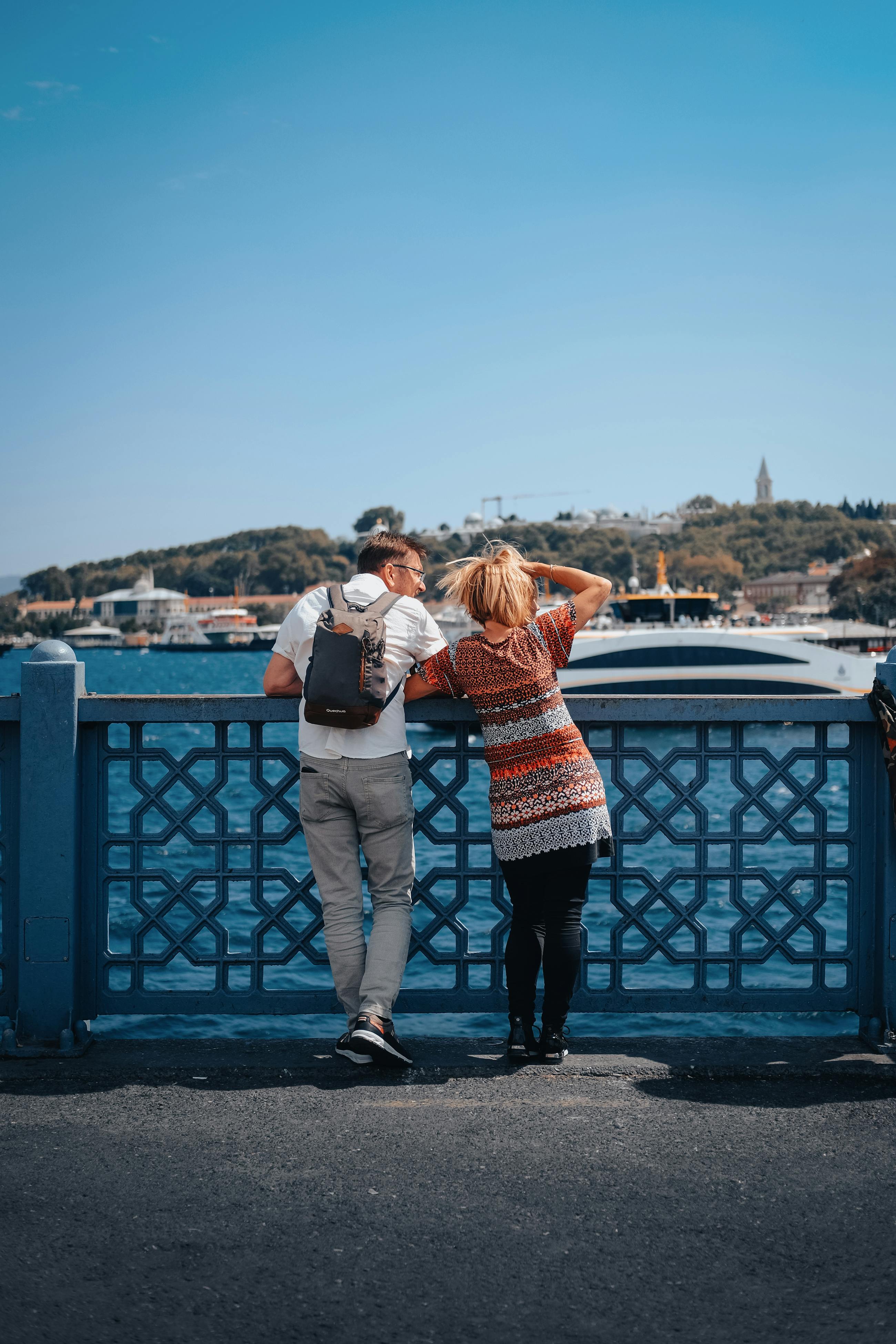 A Couple Standing Near the Metal Railings · Free Stock Photo