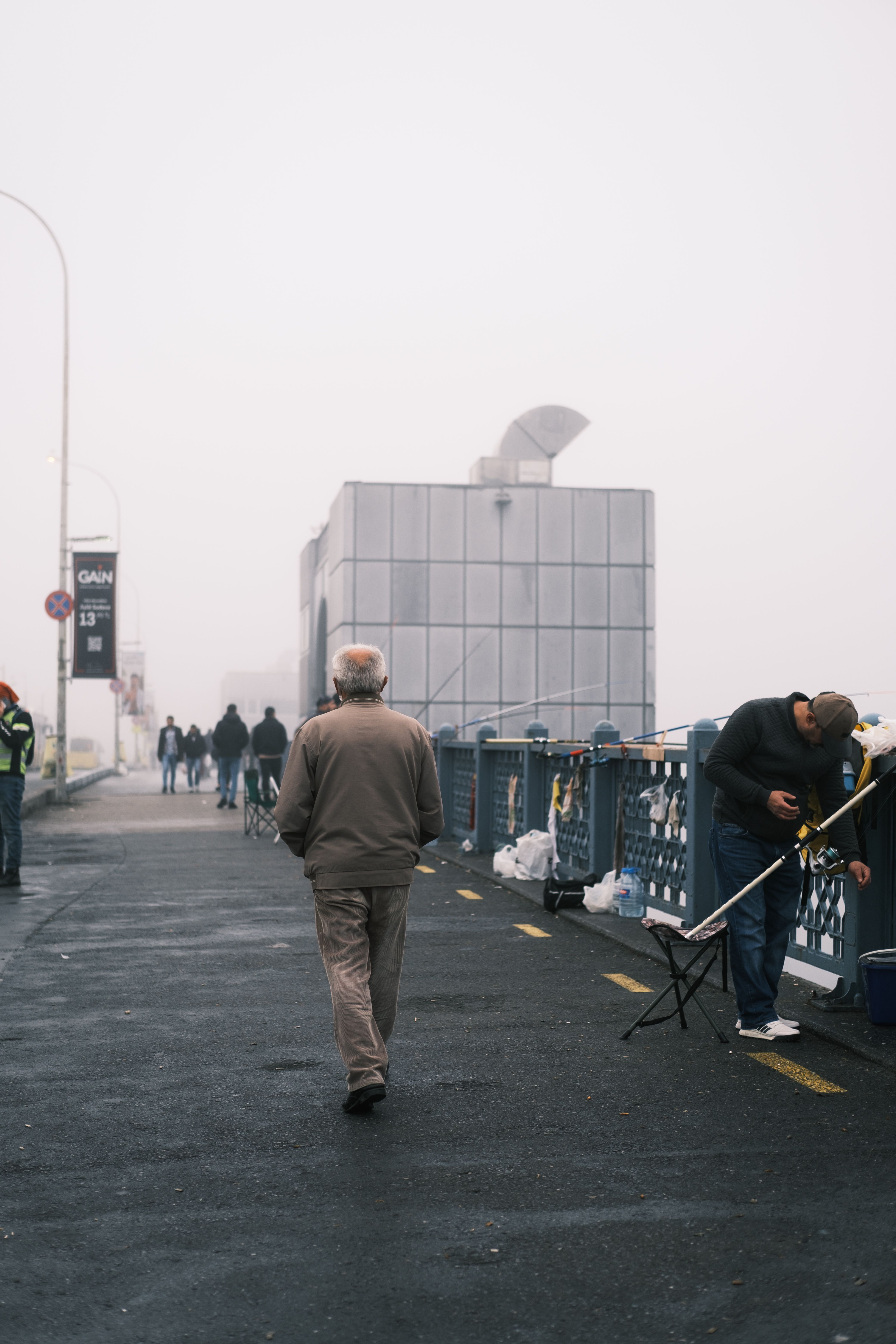 Back of a Man Walking Down a Bridge · Free Stock Photo