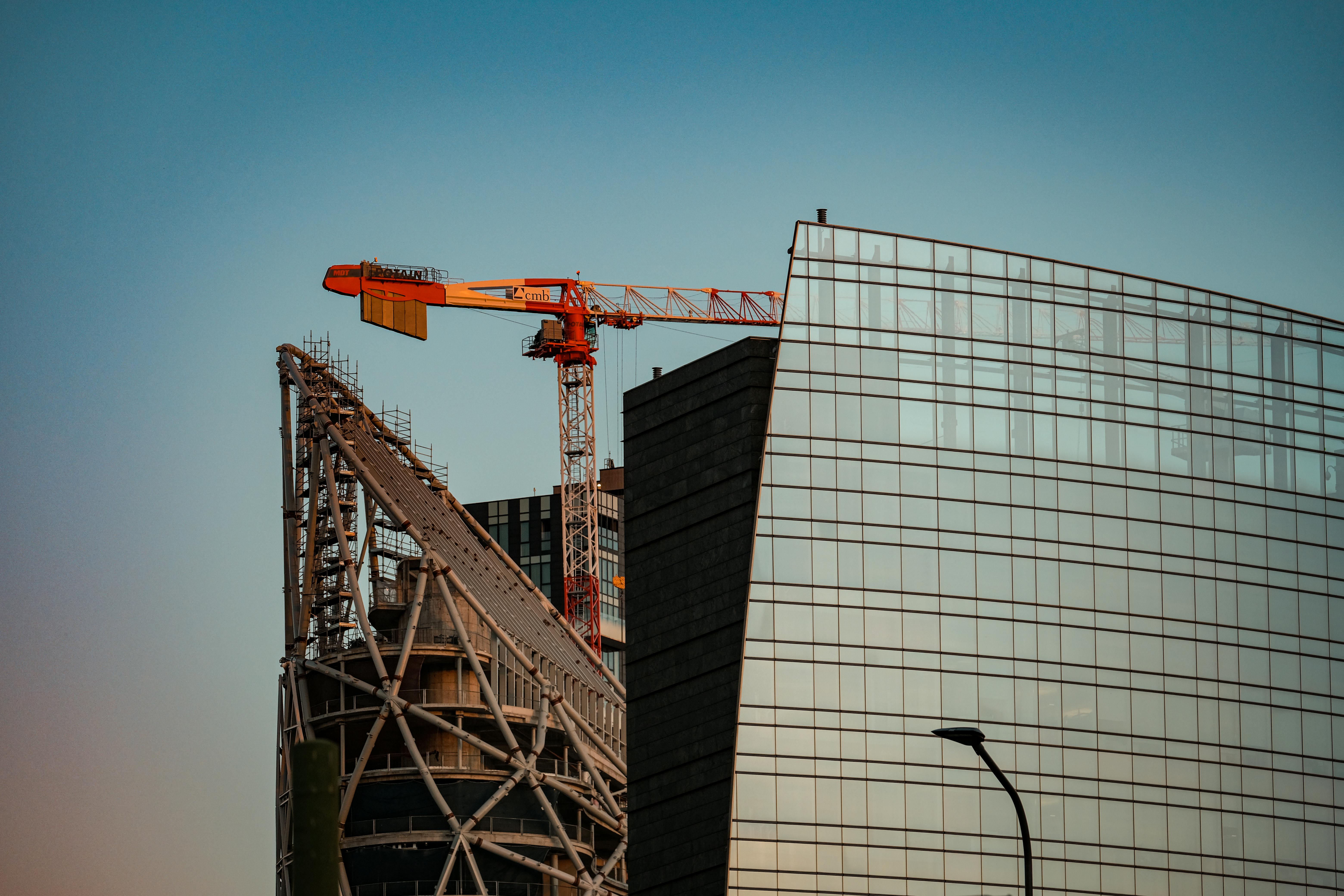 Tower Crane Beside Tall Buildings · Free Stock Photo