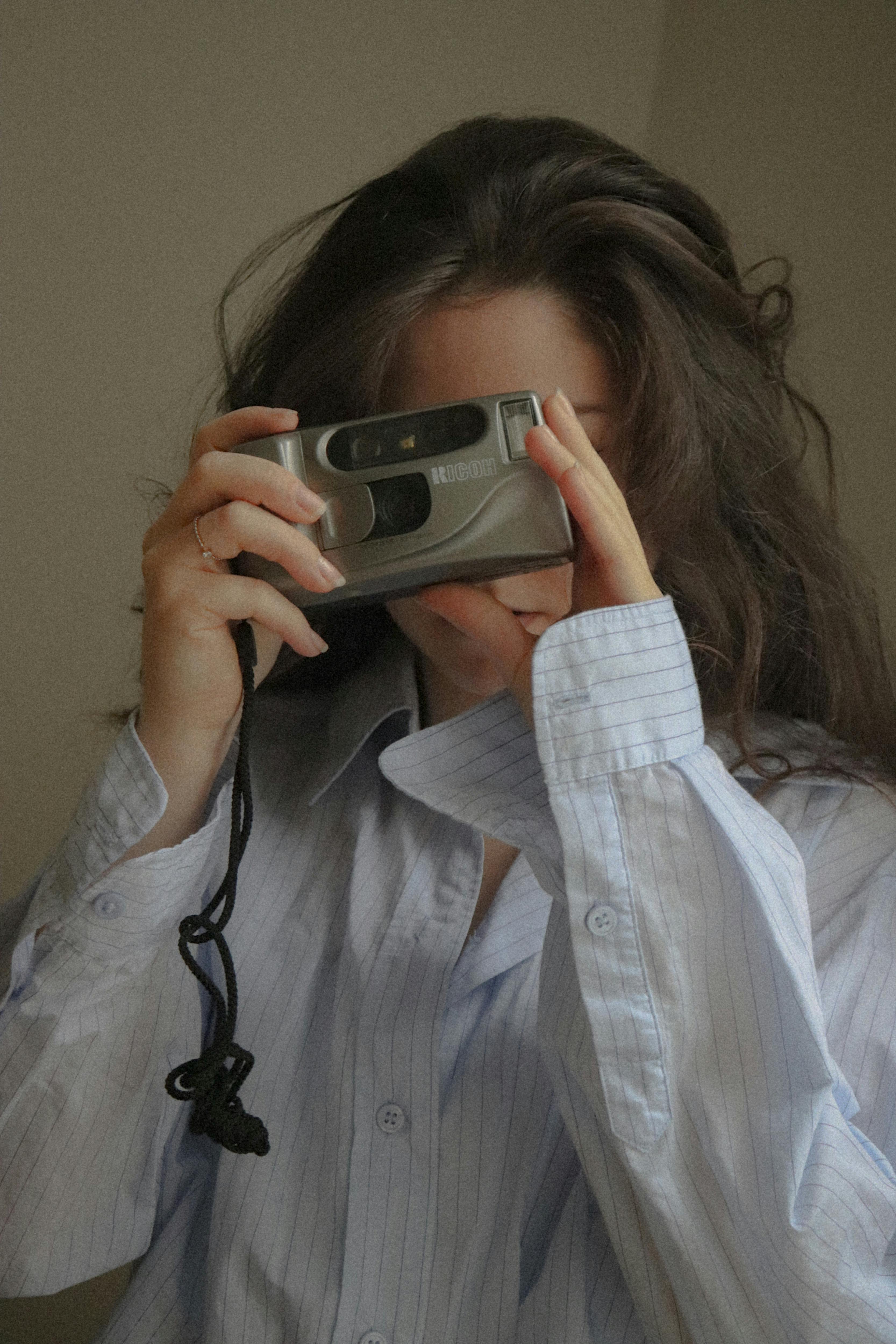 Woman in White and Blue Stripe Dress Shirt Holding a Camera · Free ...