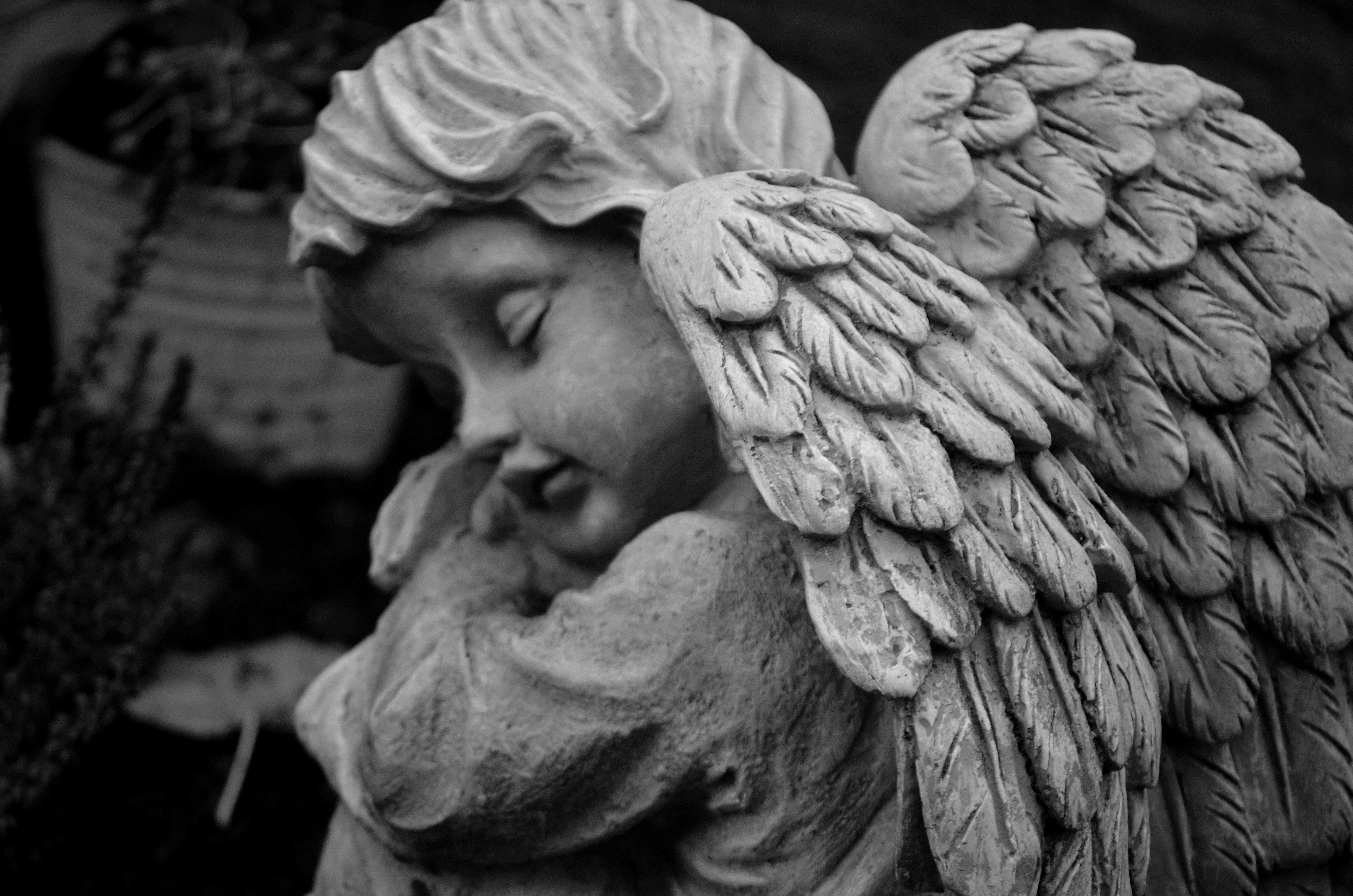 Grayscale Photo of an Angel Statue · Free Stock Photo
