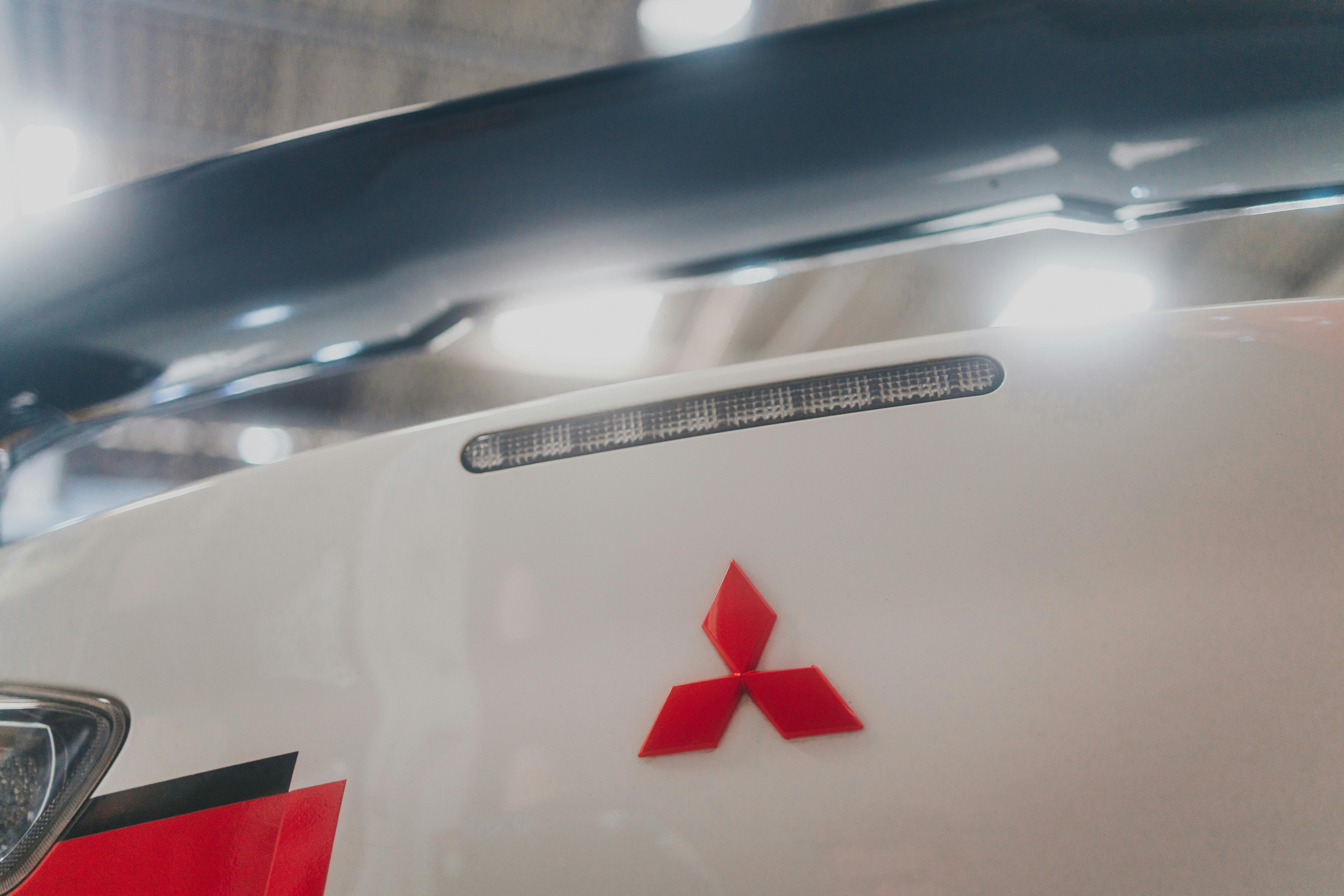 Mitsubishi Emblem on a White Car · Free Stock Photo