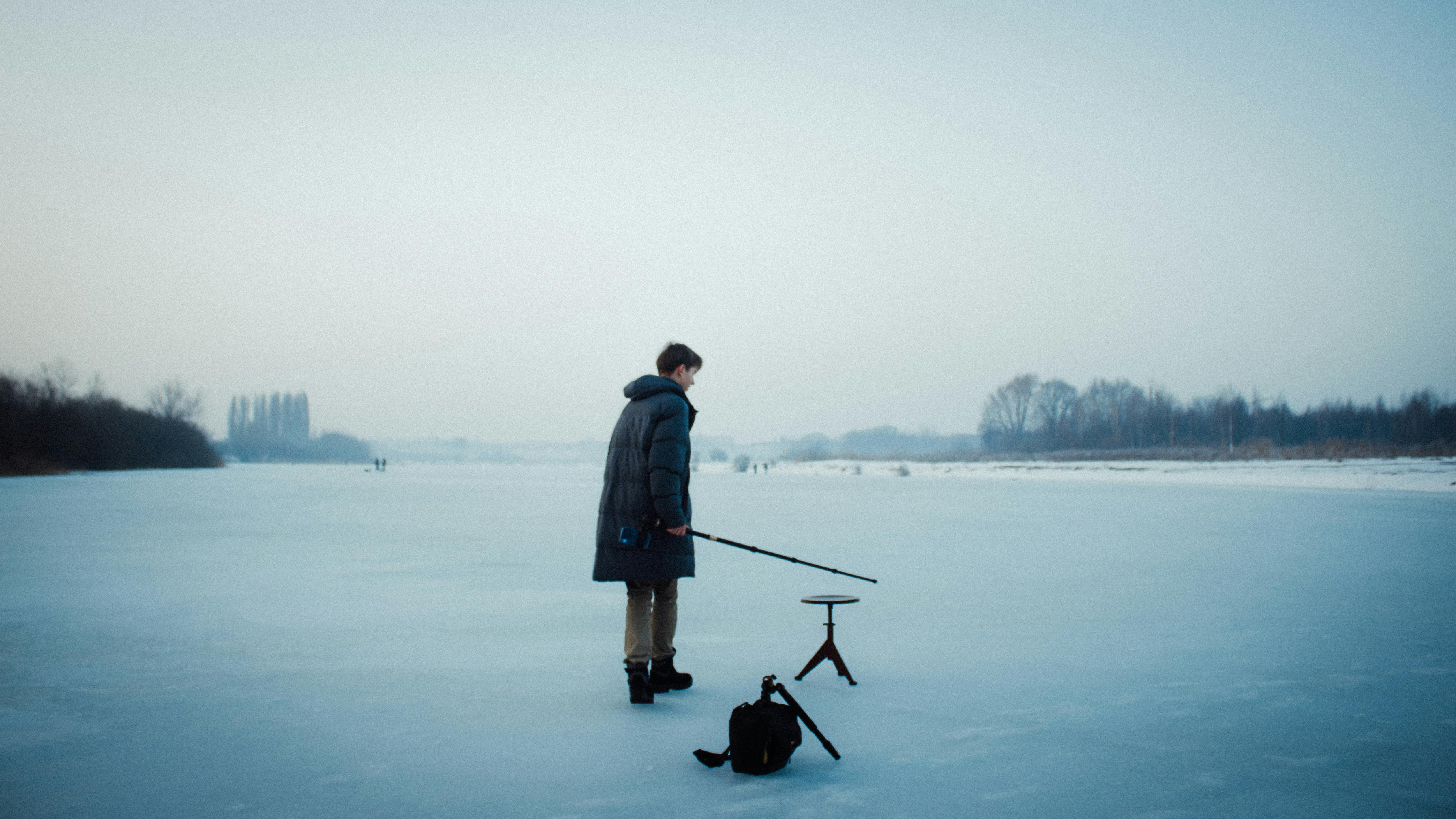 Teenager with Fishing Rod on Frozen Lake · Free Stock Photo