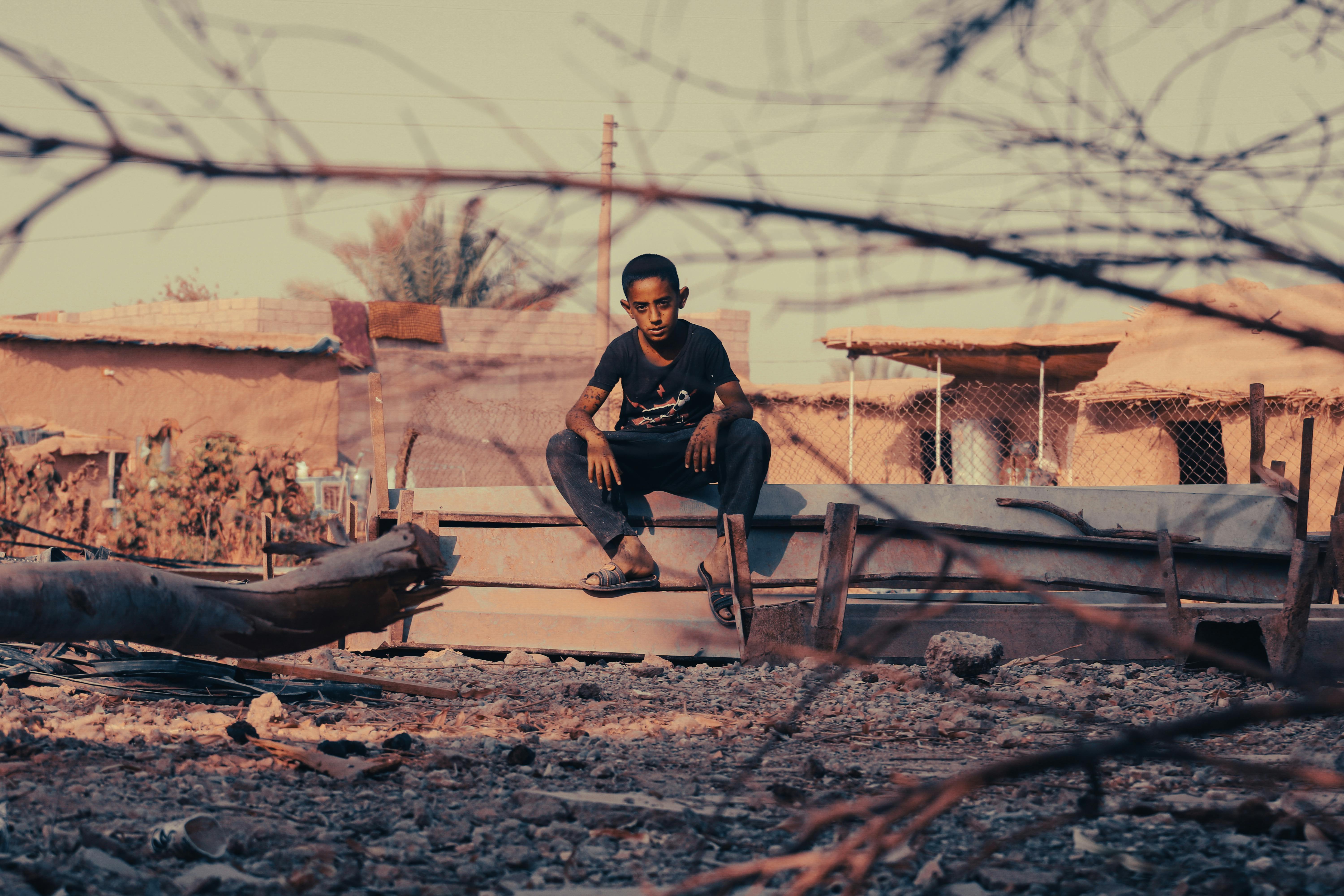 Kid Sitting on a Rusty Bench · Free Stock Photo