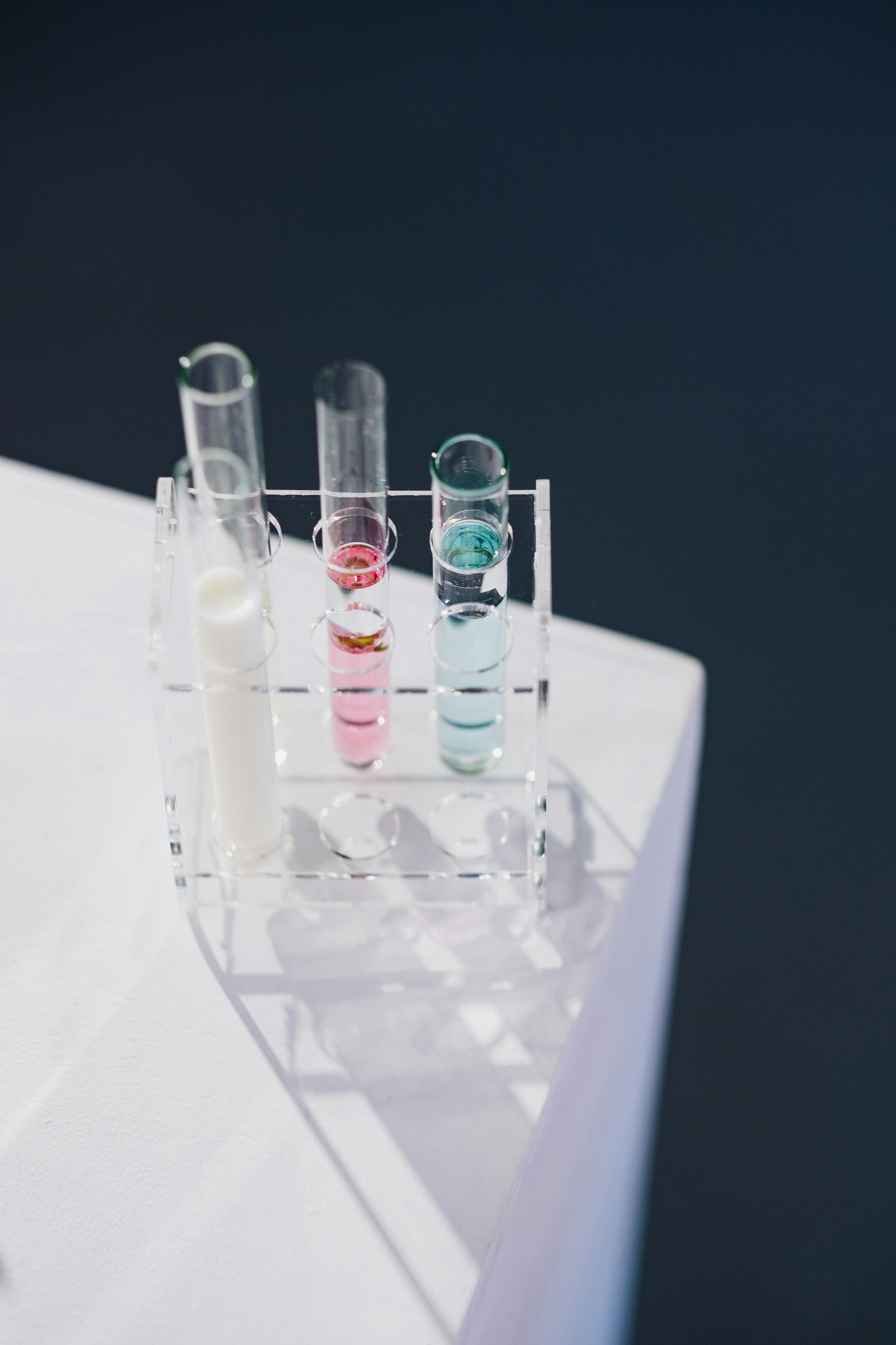 Test Tubes on Dark Blue Background · Free Stock Photo