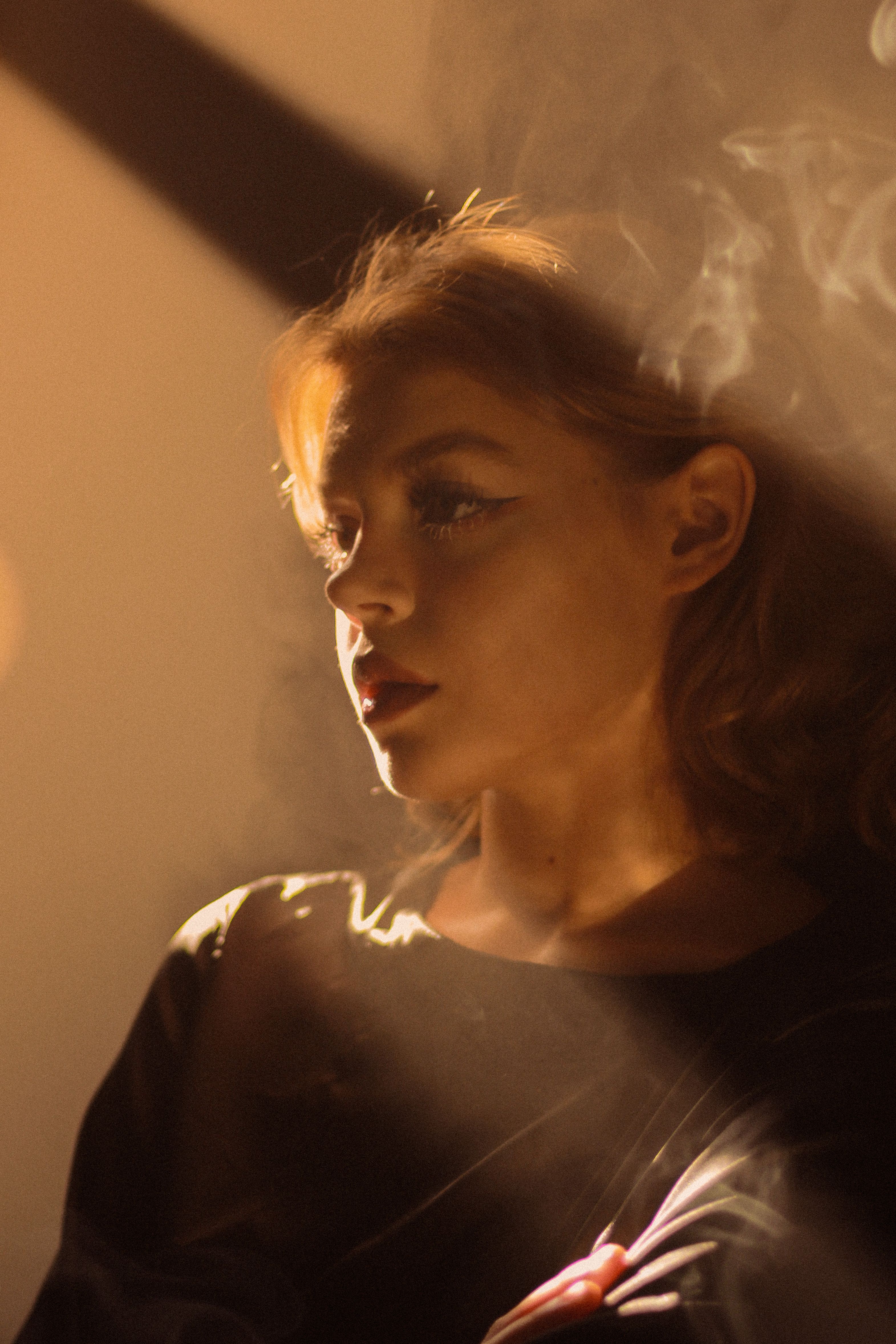 Light Rays behind Back Lit Profile of Woman · Free Stock Photo