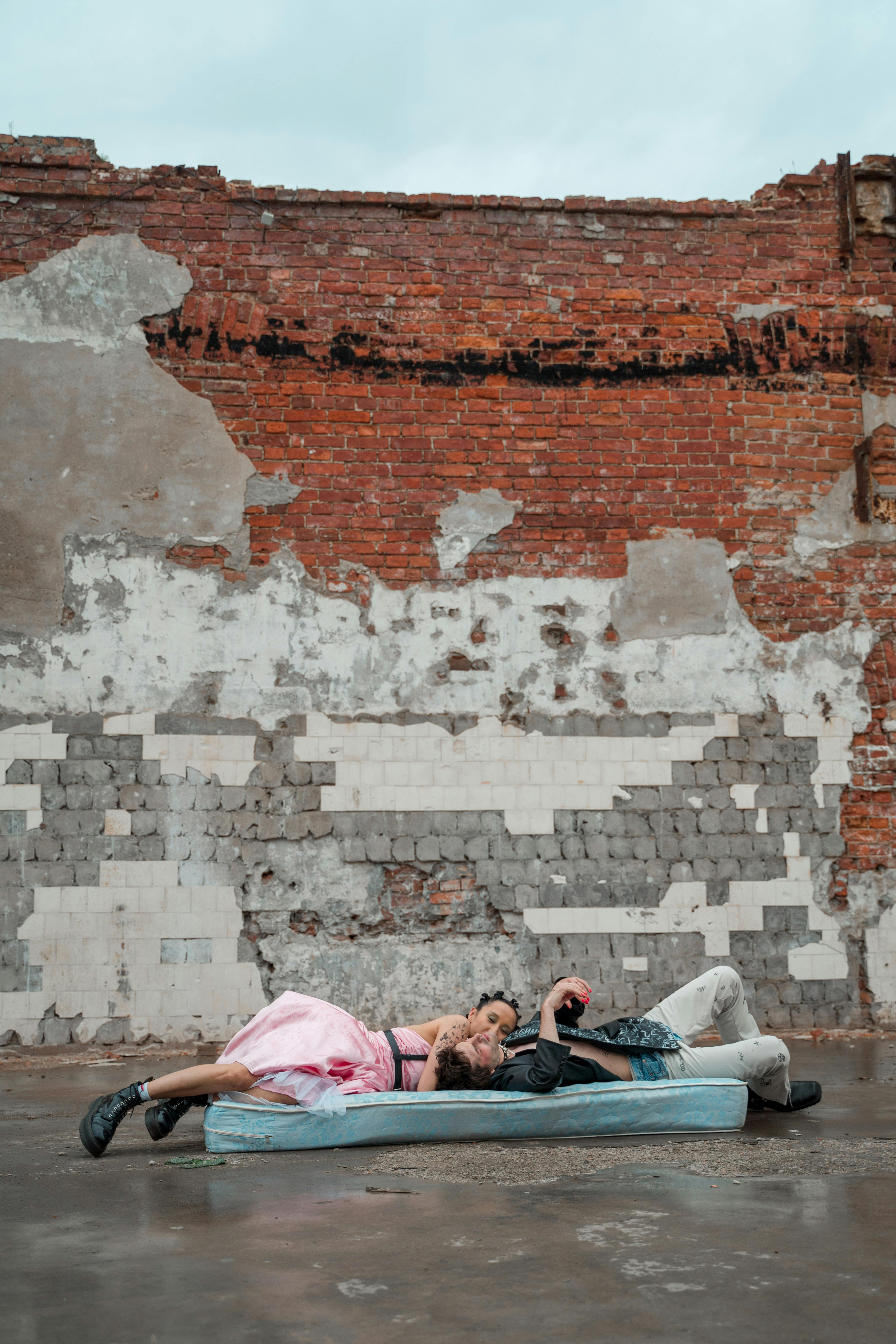 Woman in Pink Dress Lying on Blue Mattress · Free Stock Photo